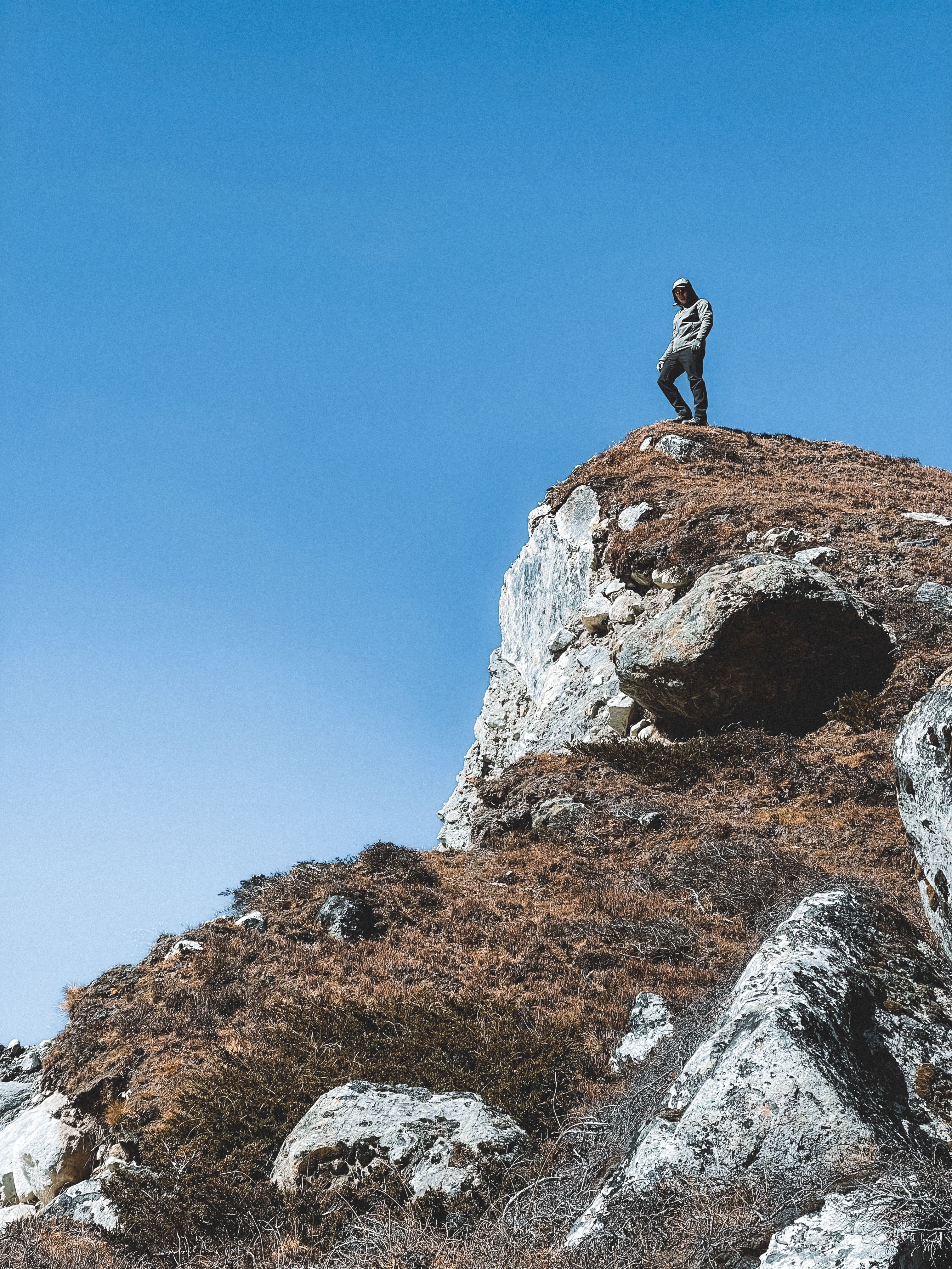 A Person Standing on the Top of the Mountain · Free Stock Photo