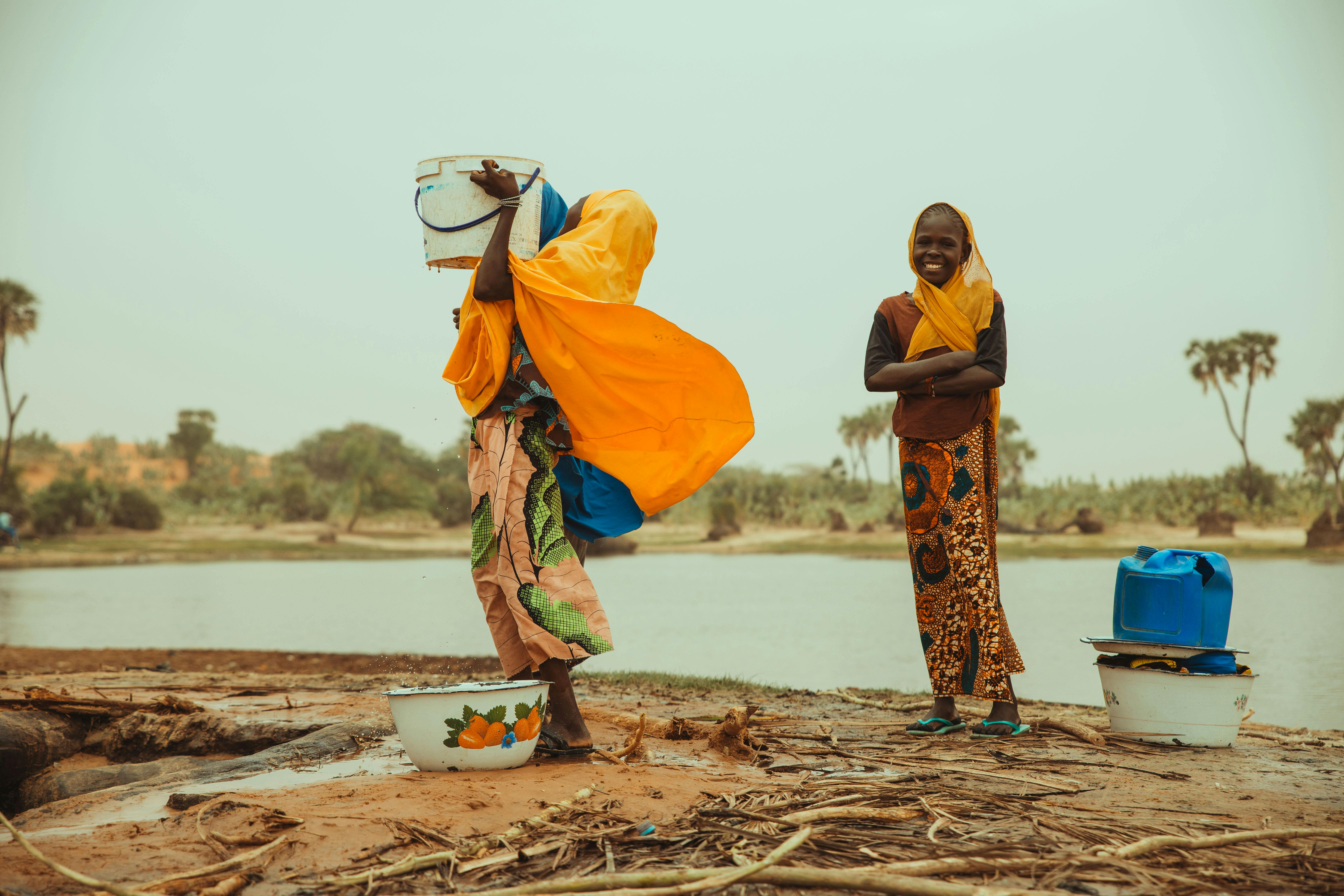 Girls Collecting Water from the Lake · Free Stock Photo