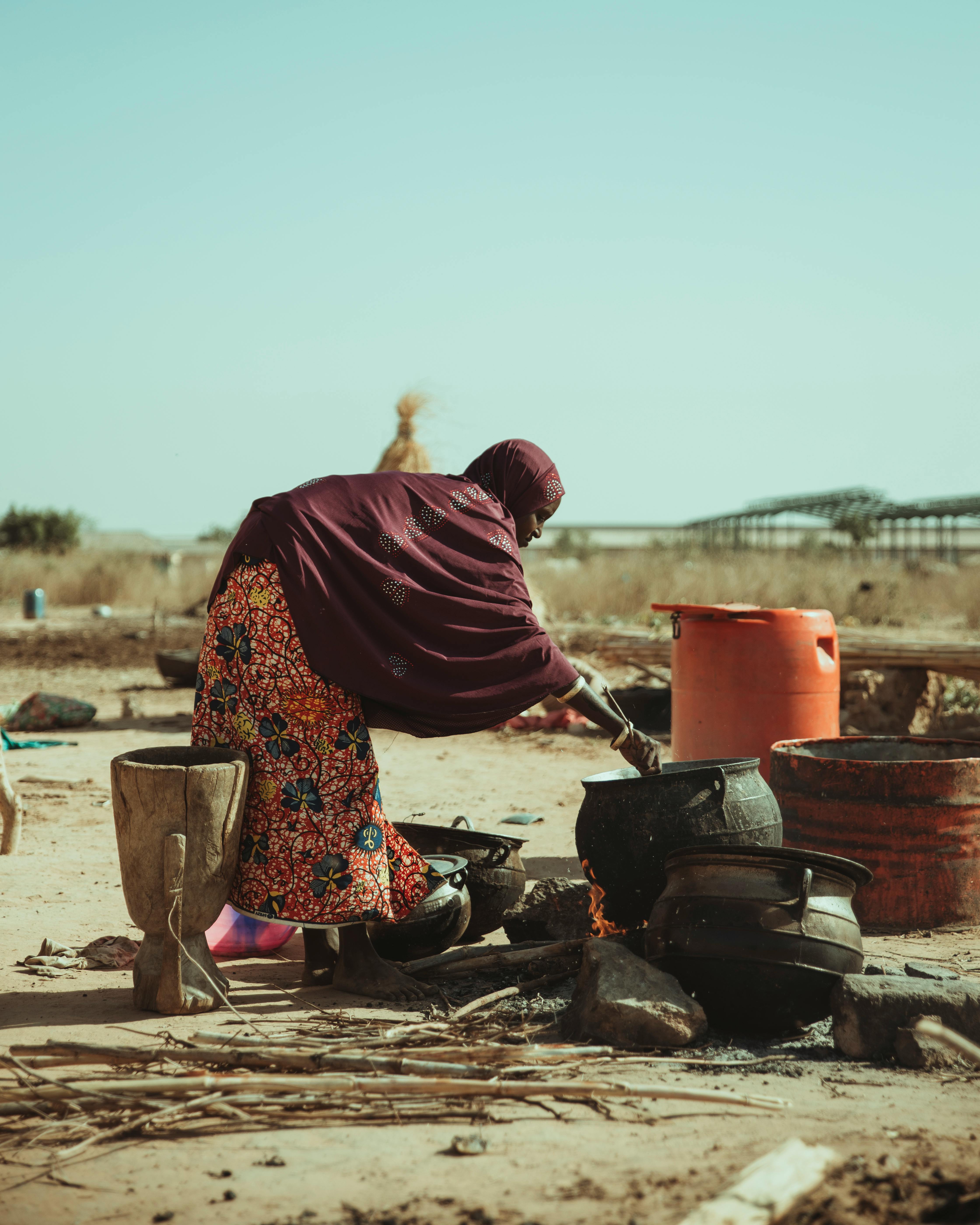 Woman Bending over Pots · Free Stock Photo