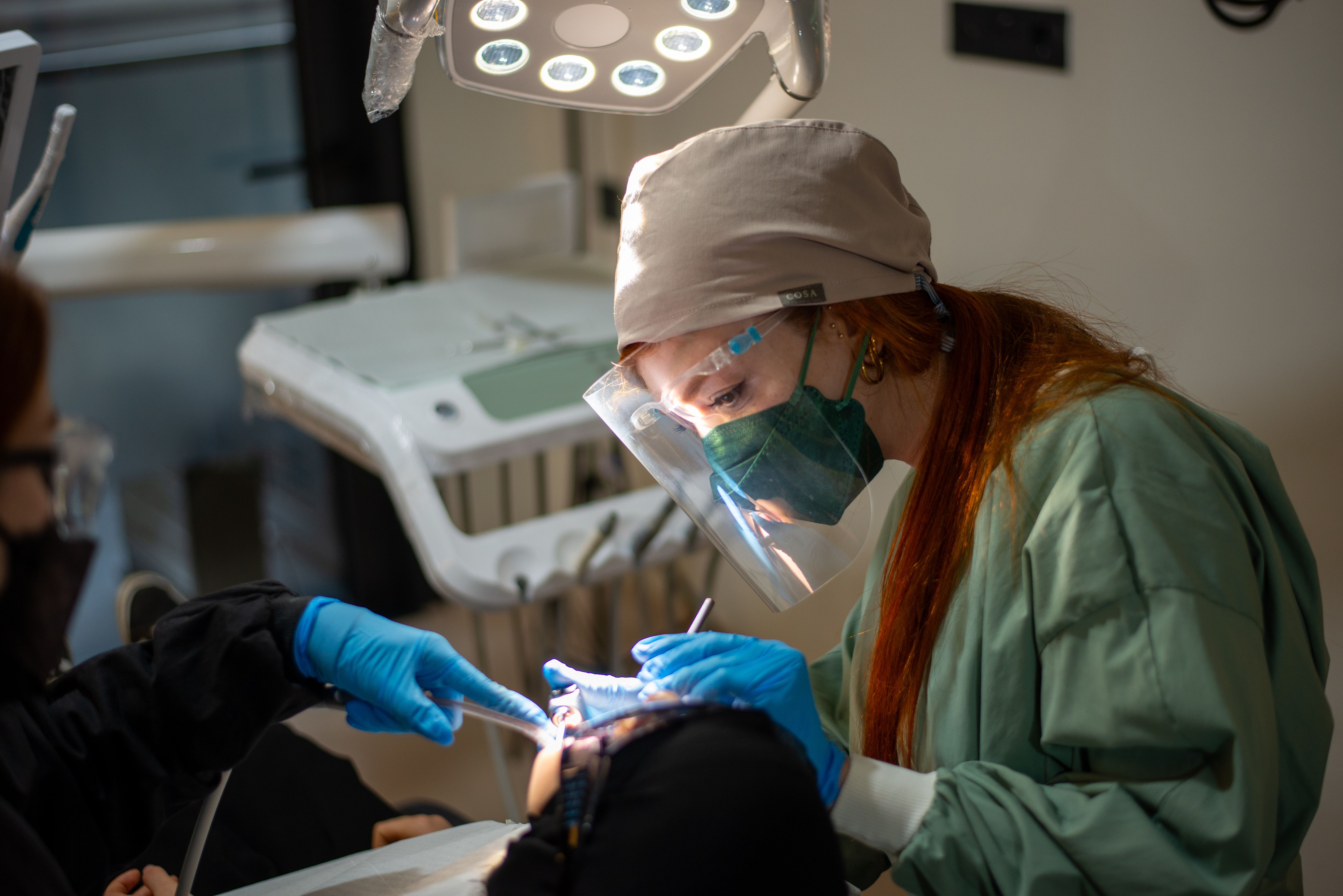 A Dentist Performing a Medical Procedure on a Patient · Free Stock Photo