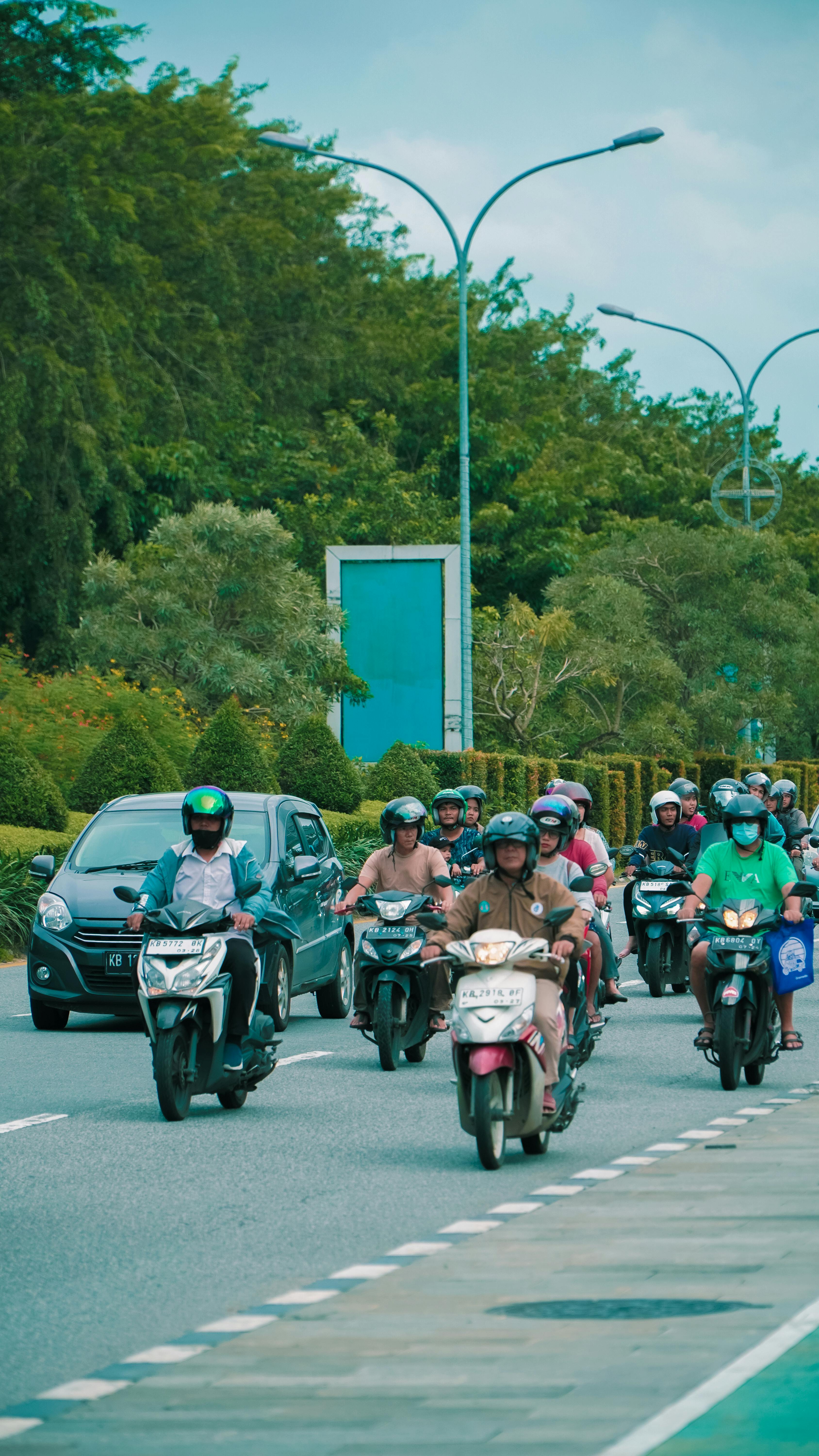 Woman Riding Motor Scooter Travelling on Asphalt Road during Sunrise ...