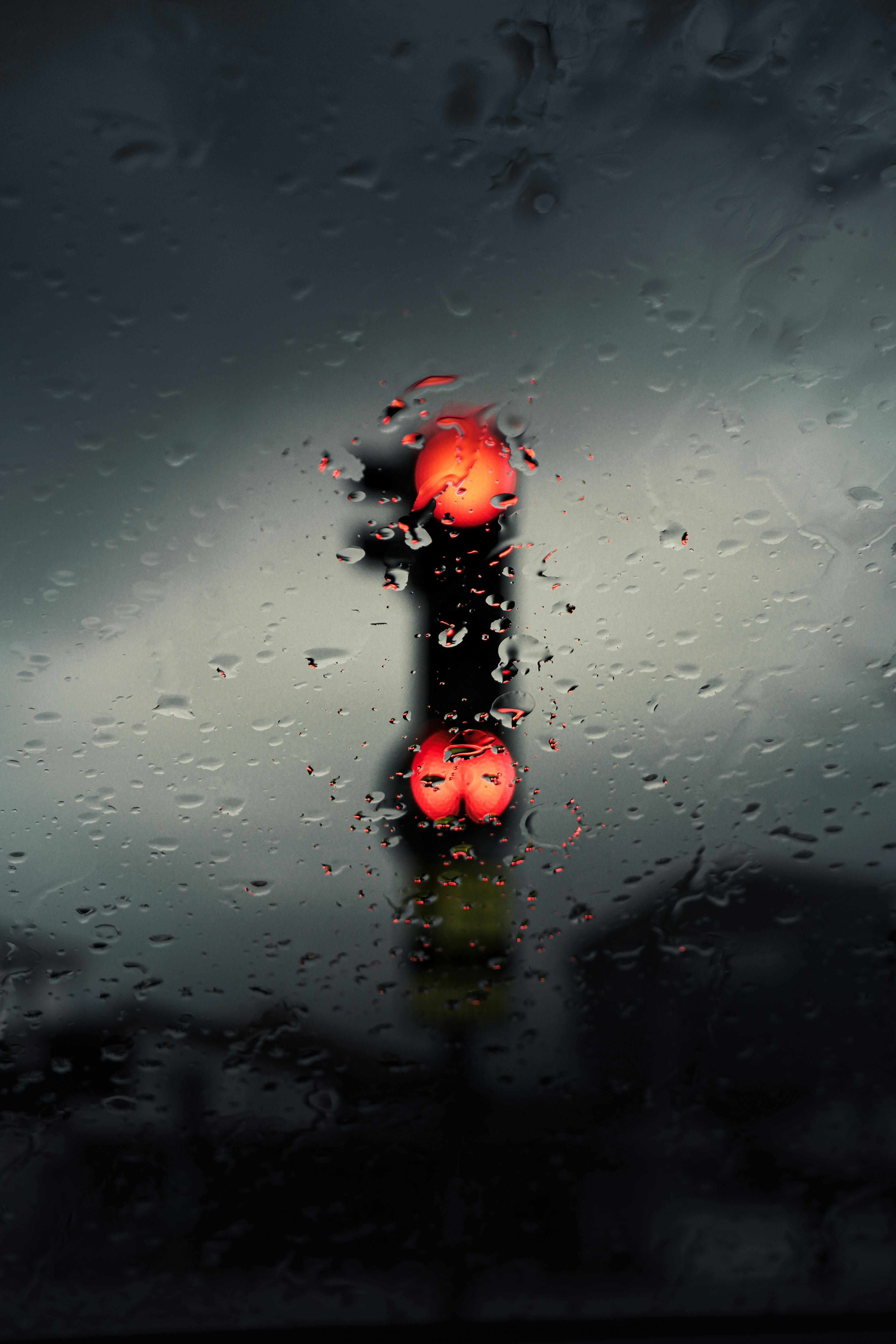 Red Lights behind Wet Window · Free Stock Photo