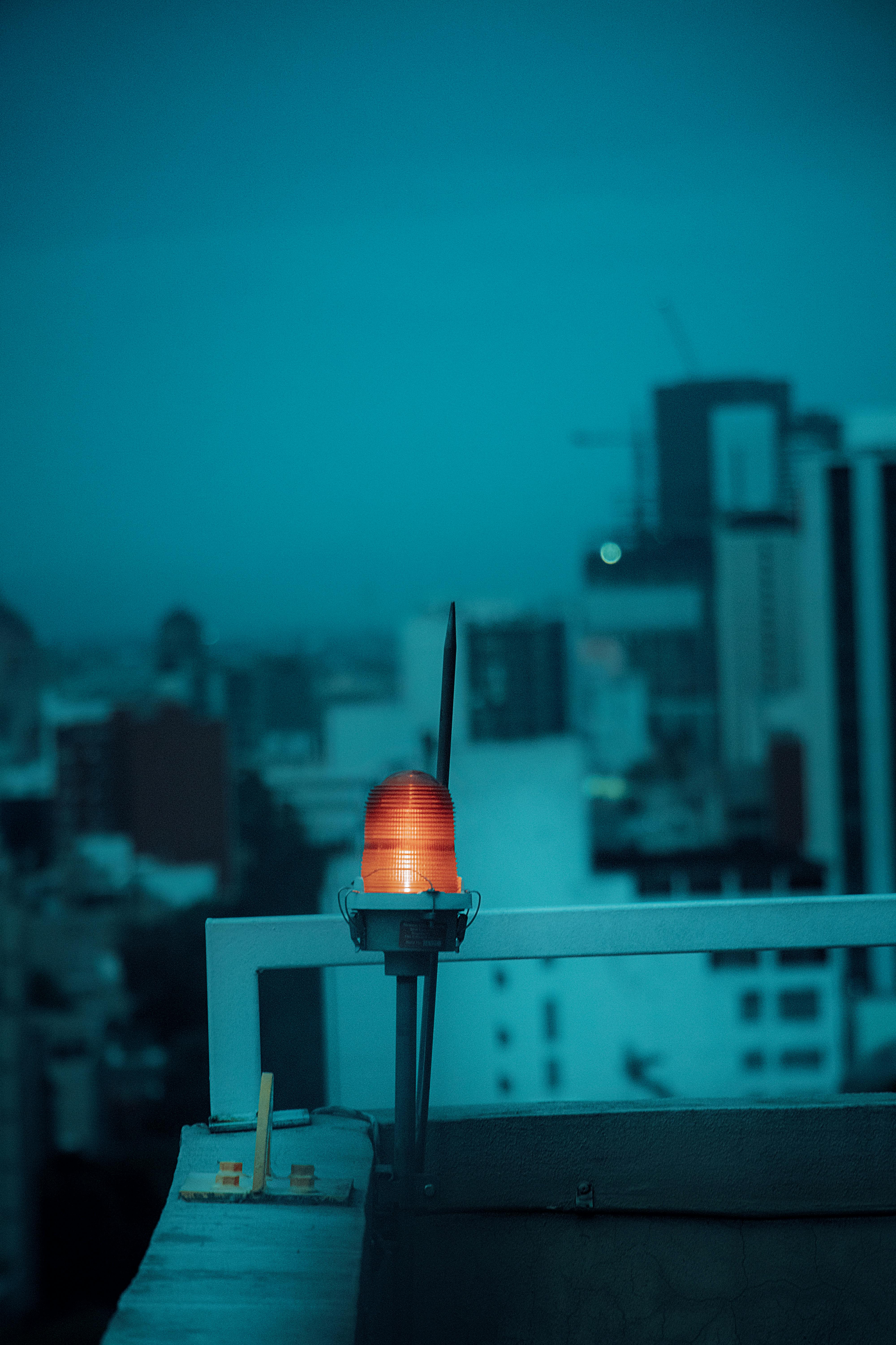 Close-up of a Red Light on Top of a Building in City · Free Stock Photo
