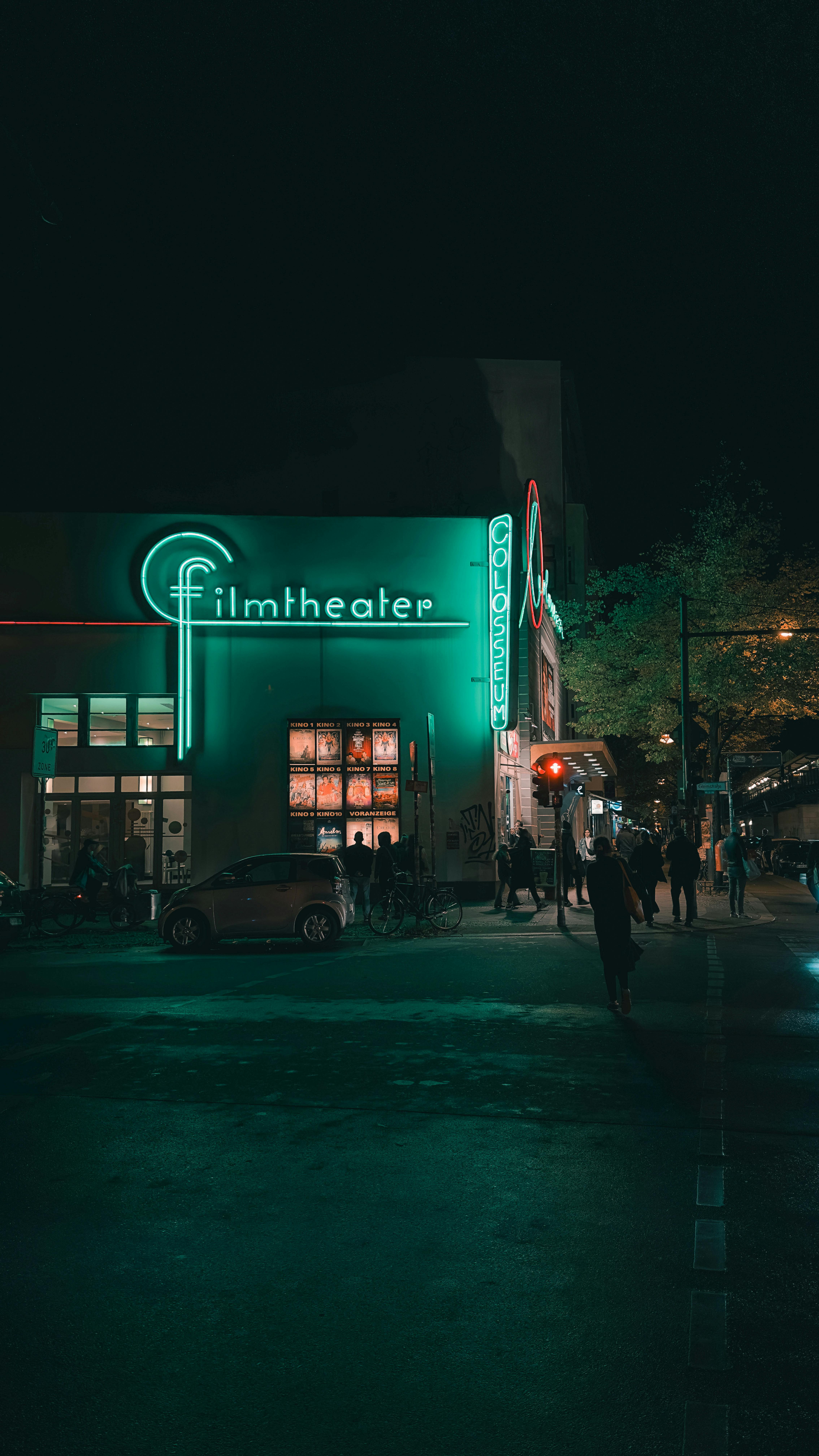 A green neon sign lit up at night · Free Stock Photo