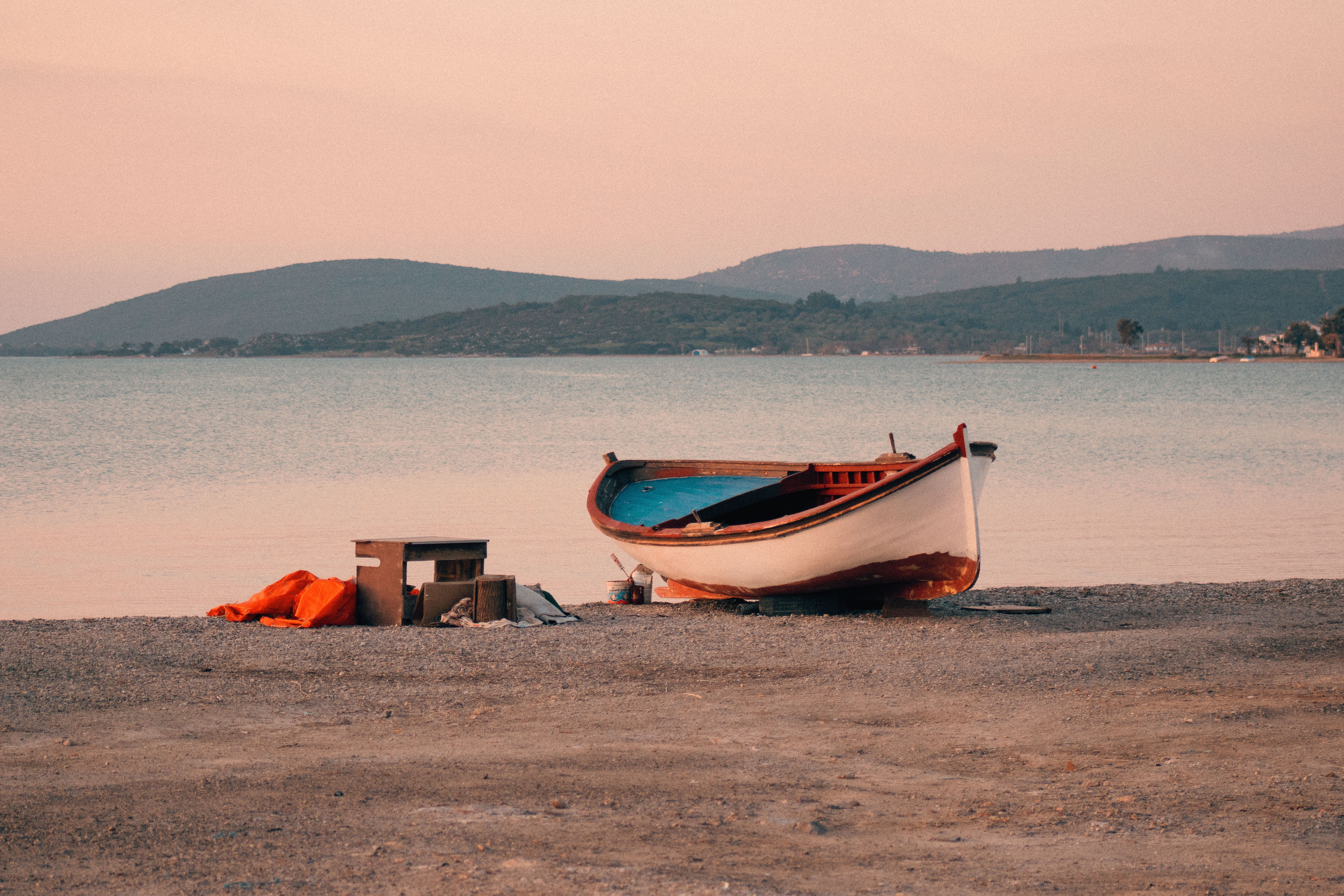 Small moored boat on peaceful lake in highlands · Free Stock Photo