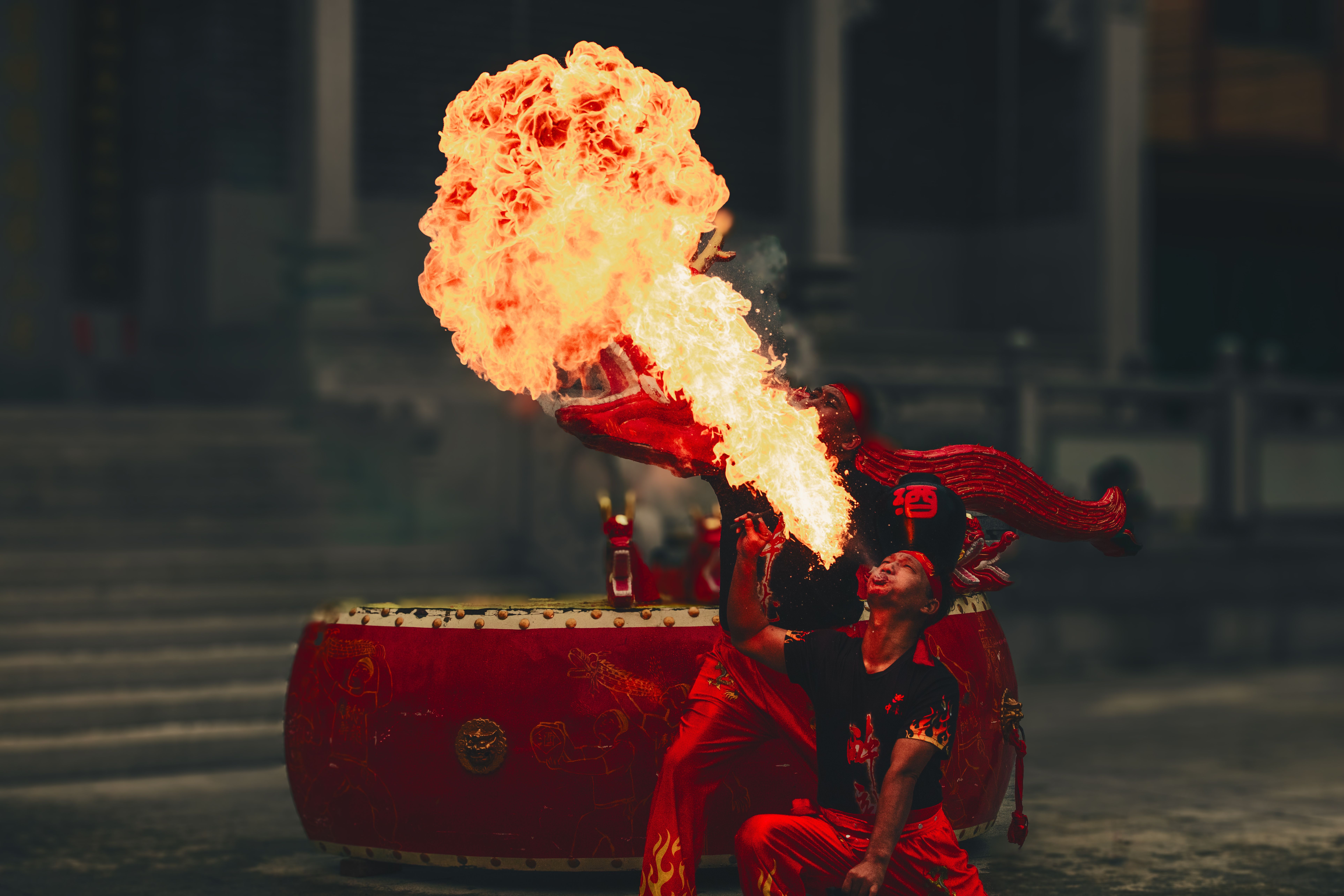 A man in red is holding a fire in his hand · Free Stock Photo