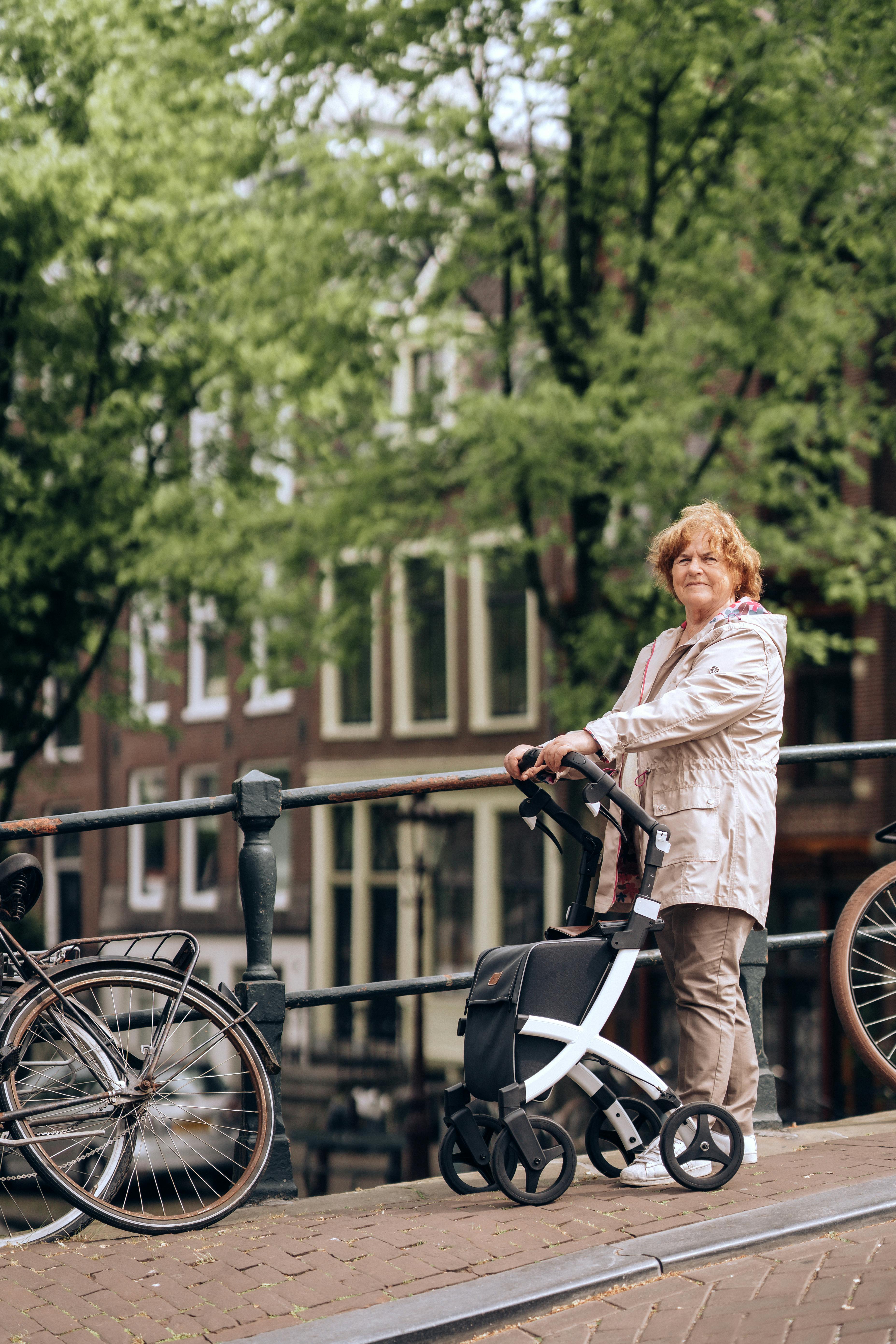 Elderly woman walking with a rollator walker · Free Stock Photo