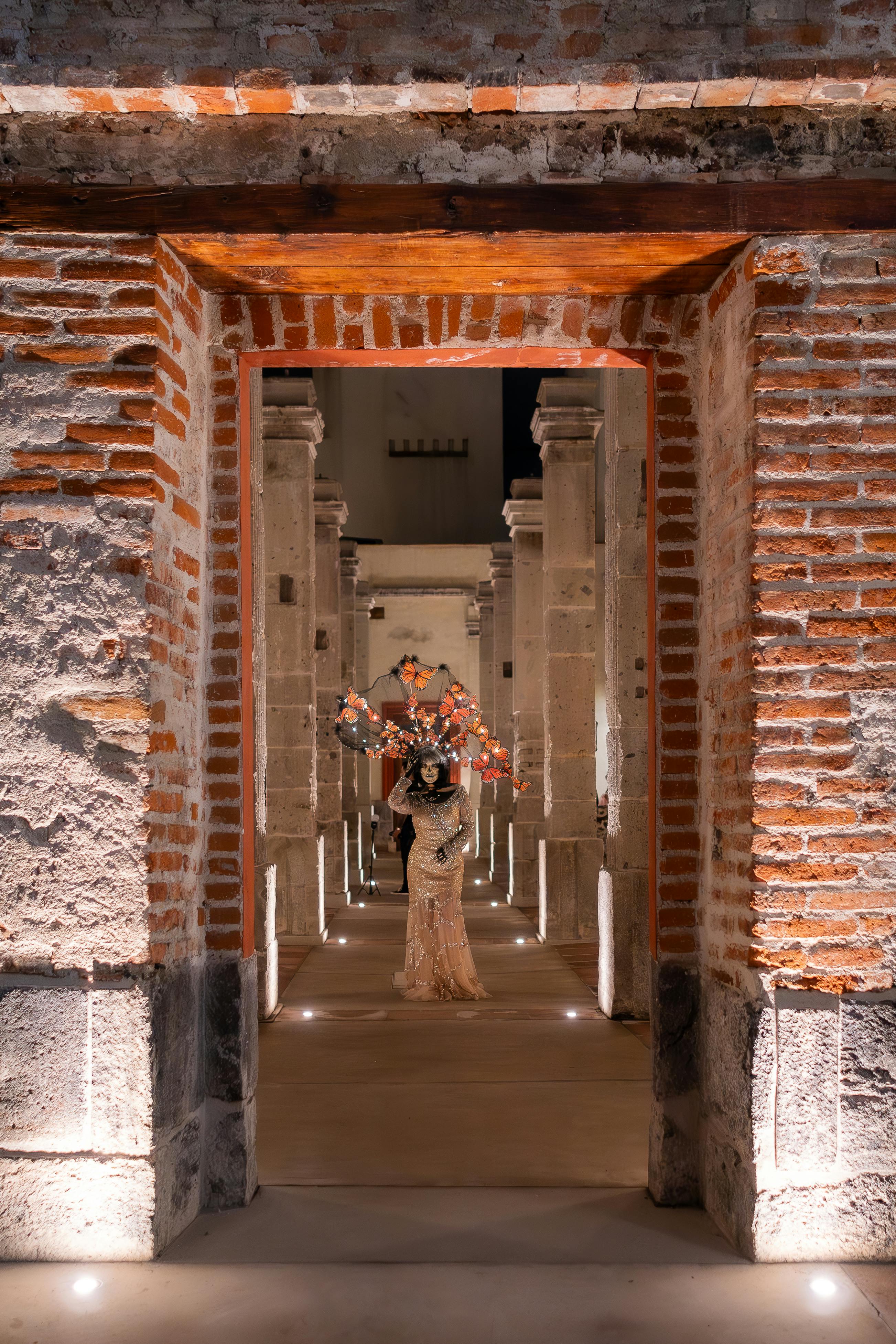 Catrina in Dress Standing behind Walls · Free Stock Photo