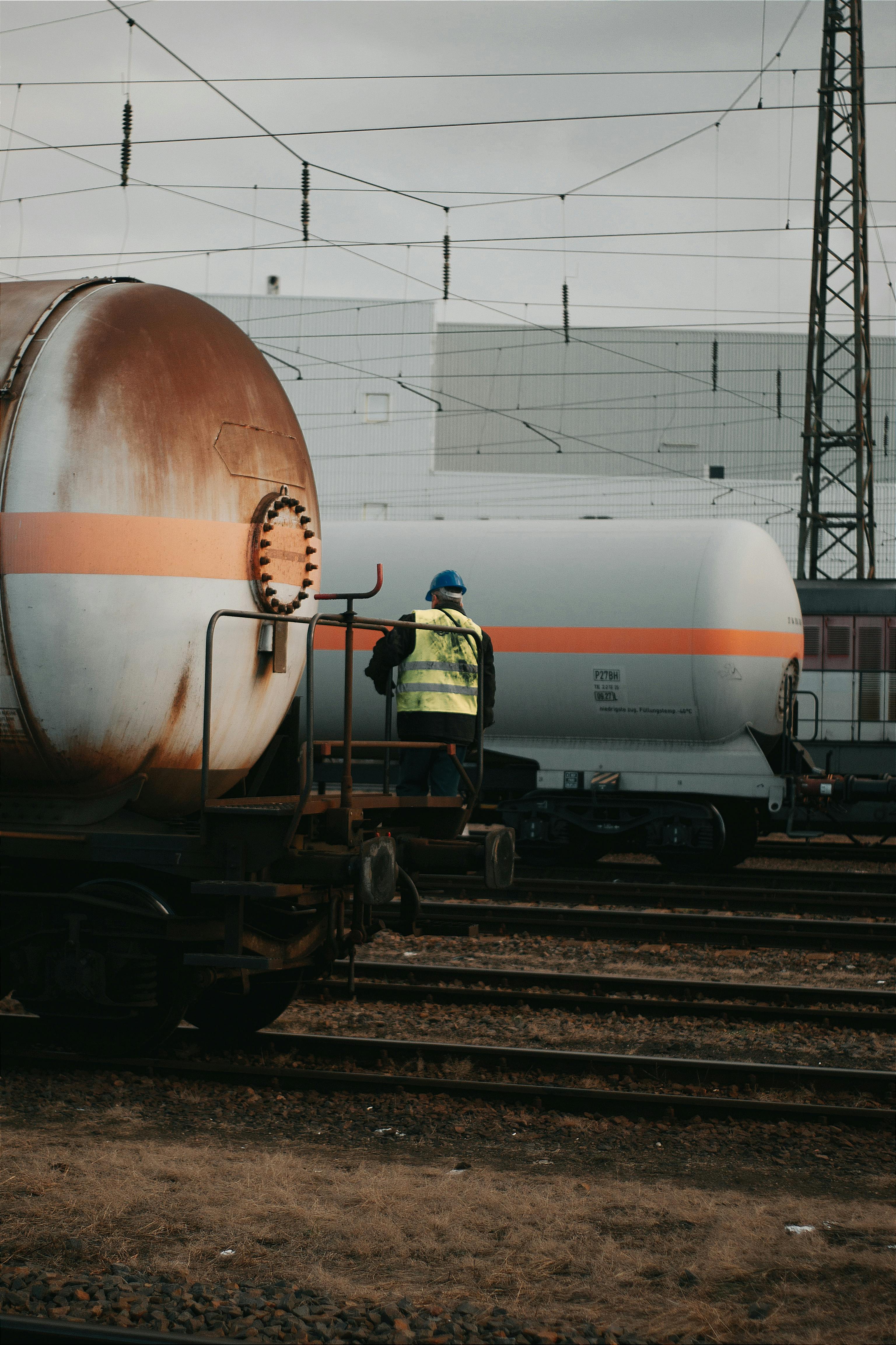 Worker between Cargo Train Cars · Free Stock Photo