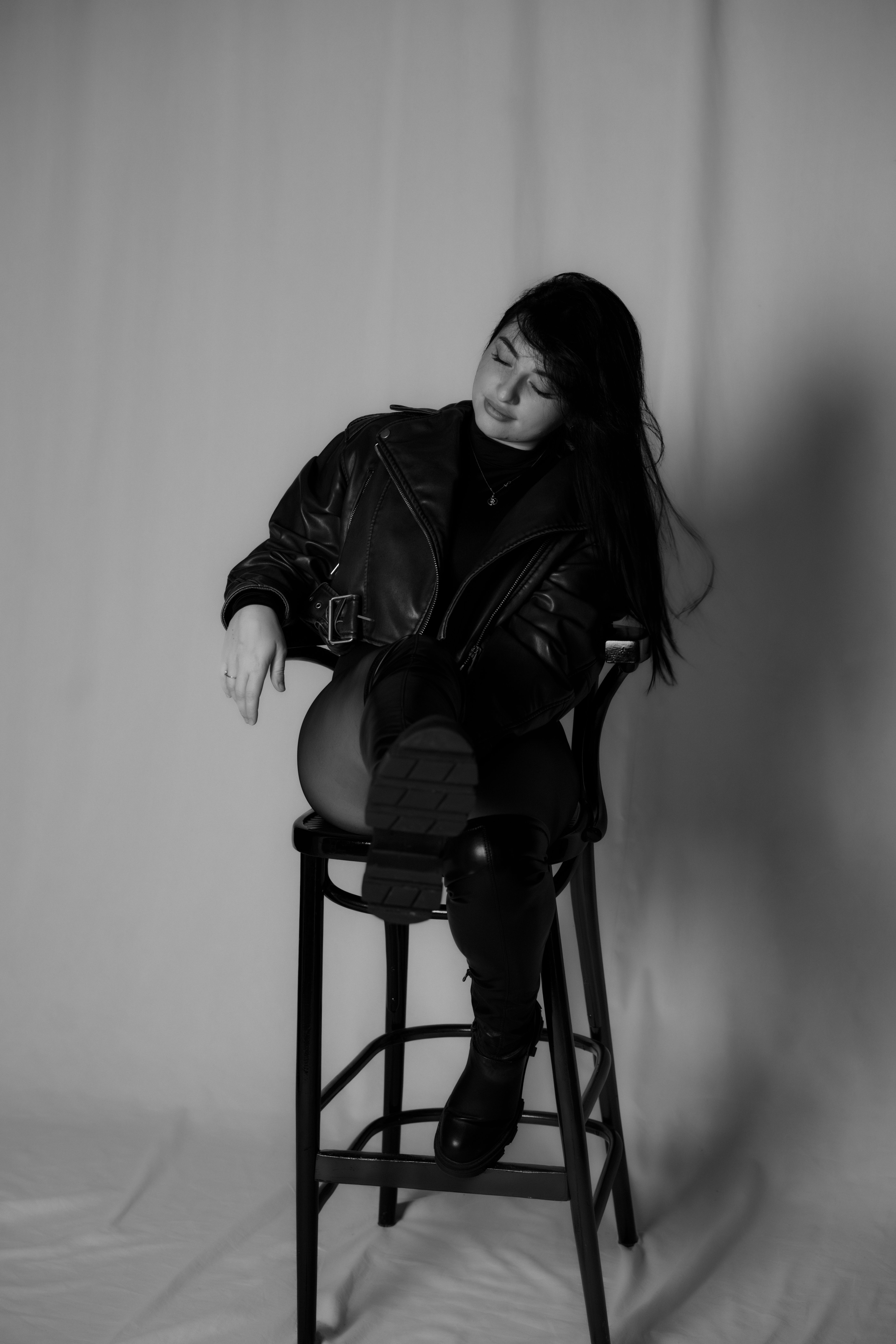 Woman in Leather Jacket Sitting on Chair · Free Stock Photo