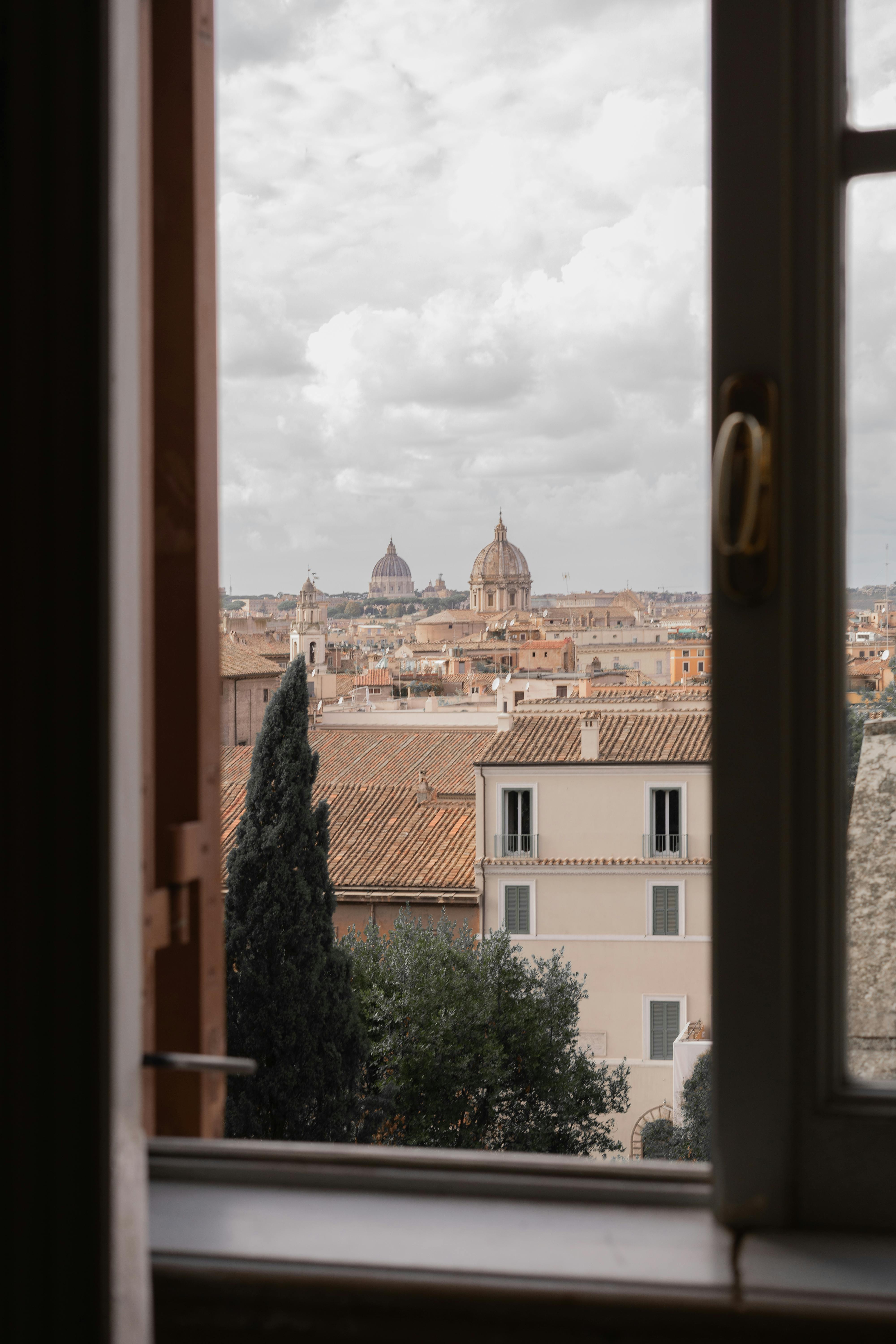 Roofs of Buildings in Rome behind Window · Free Stock Photo