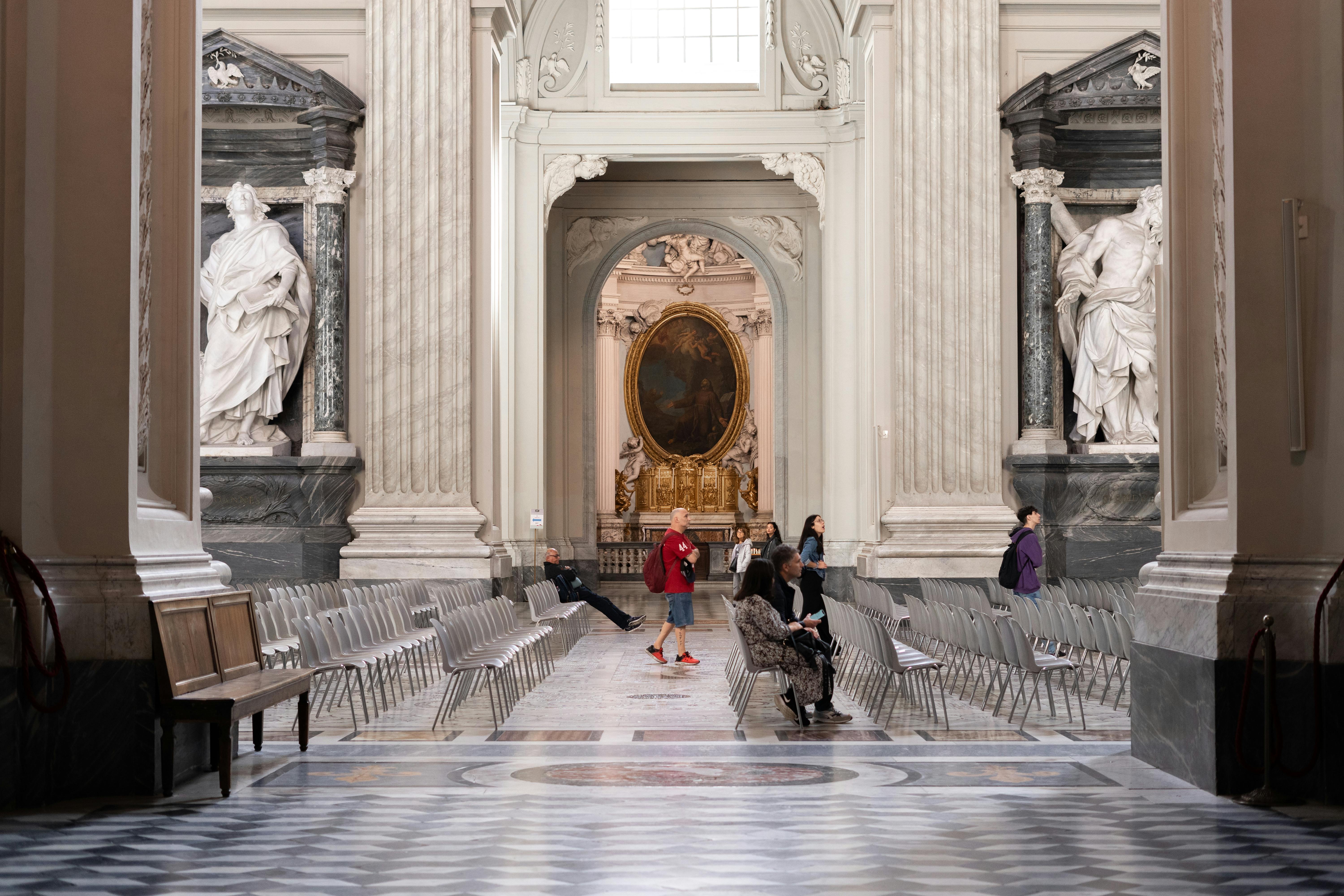A large cathedral with people walking around · Free Stock Photo