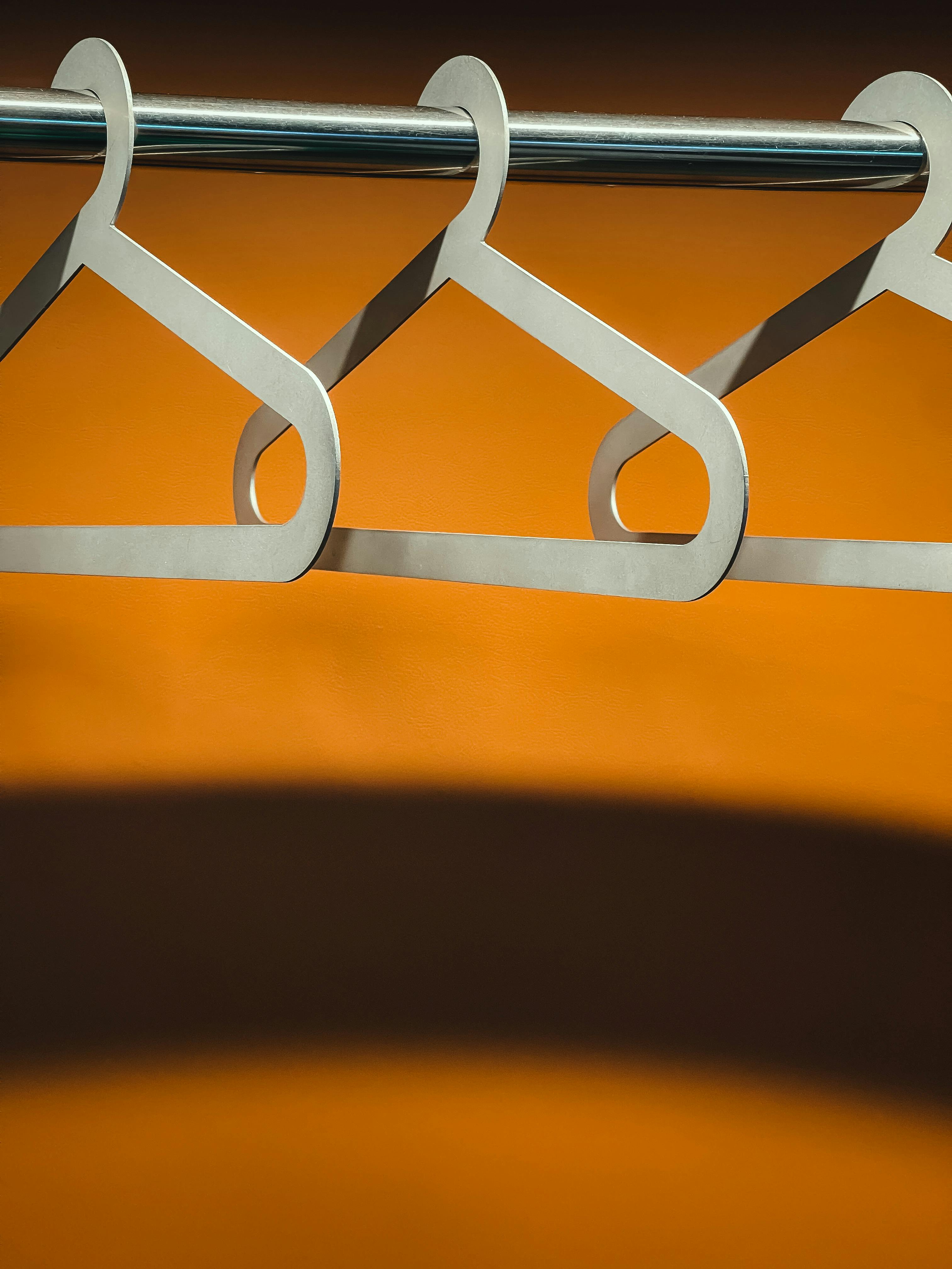 A Wooden Hanger Hanging on a Rack · Free Stock Photo