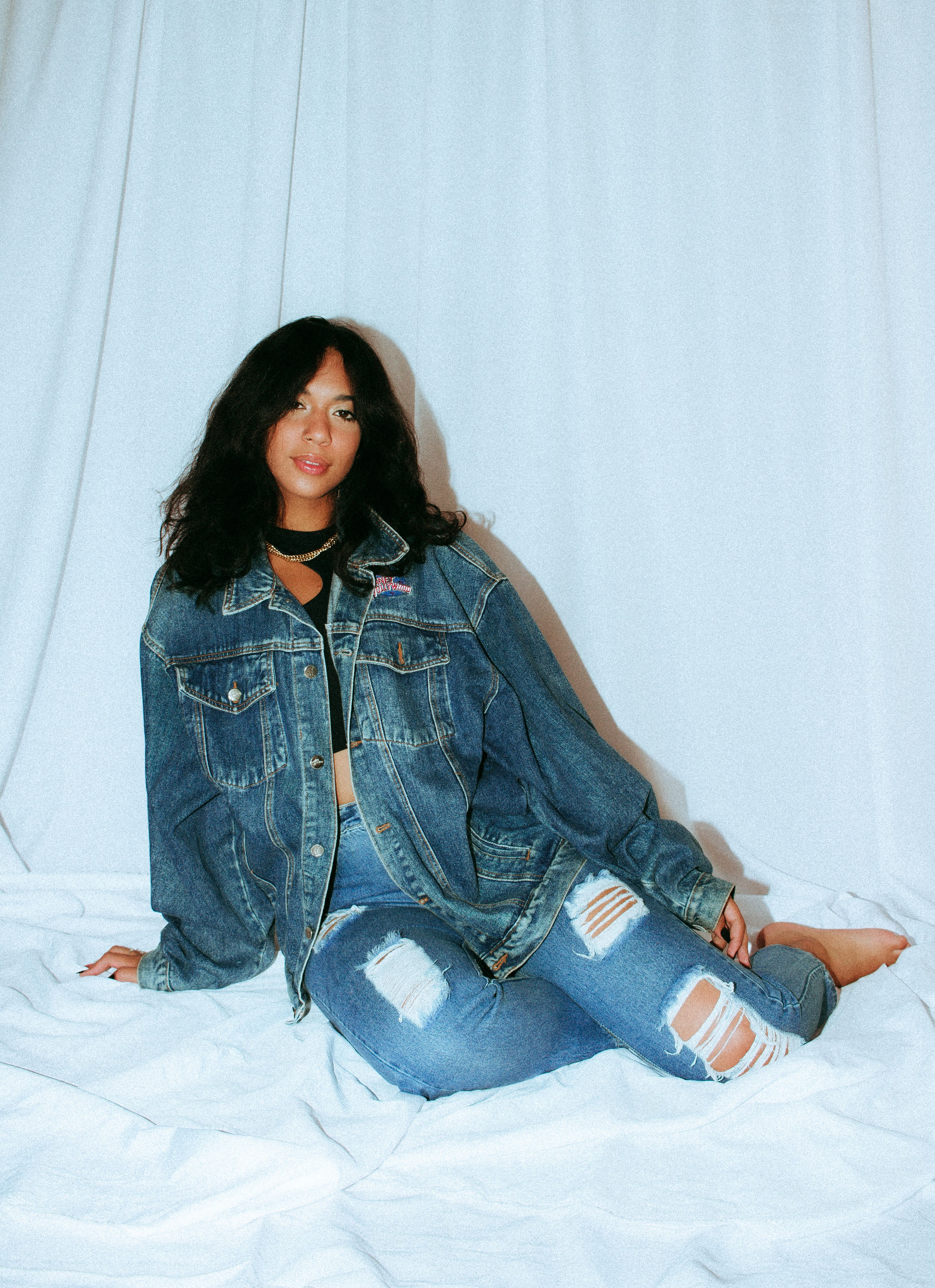 Model Posing in Denim Jacket and Ripped Jeans · Free Stock Photo