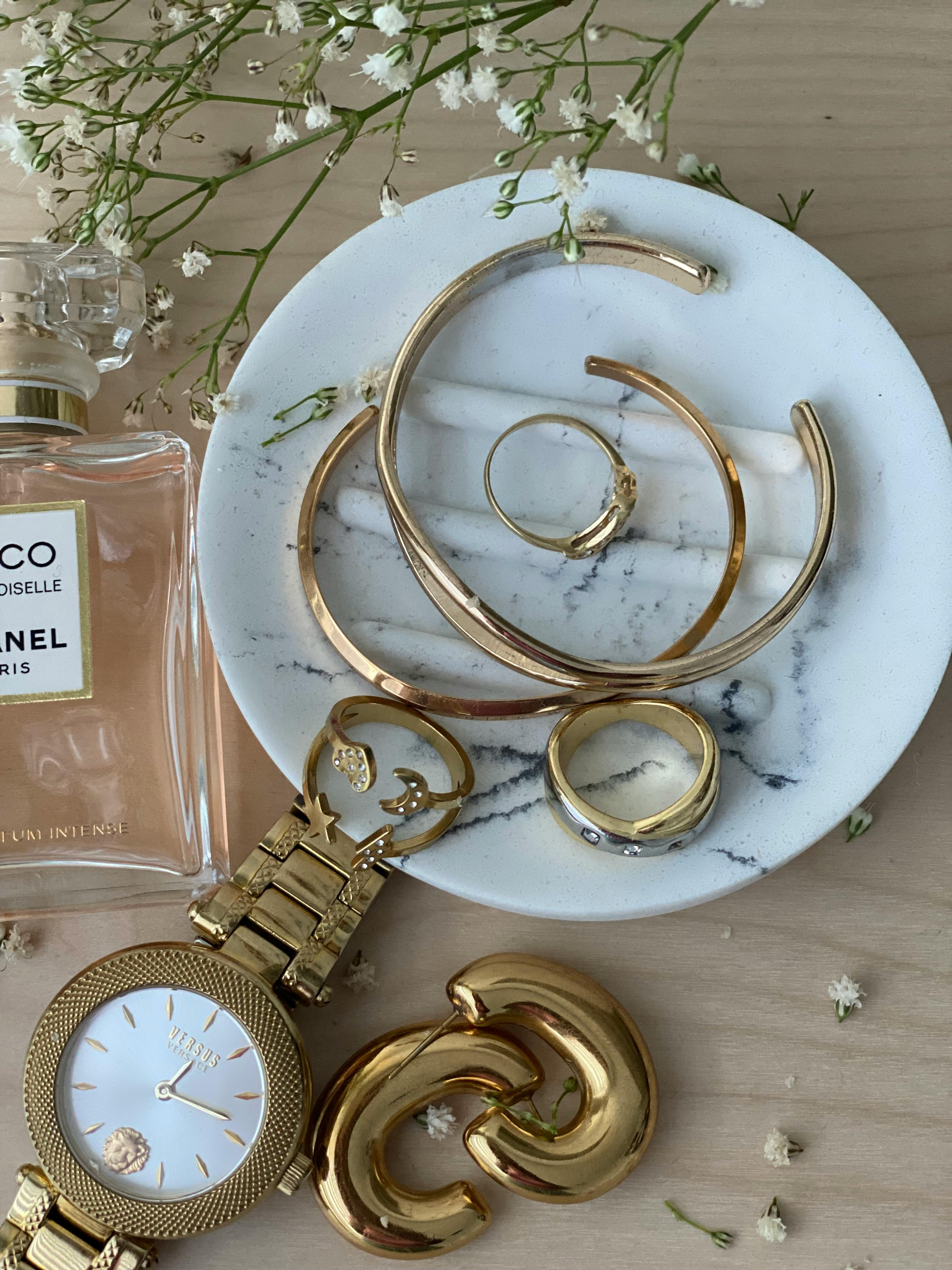 Gold-colored Analog Watch on Beige Wood Surface · Free Stock Photo