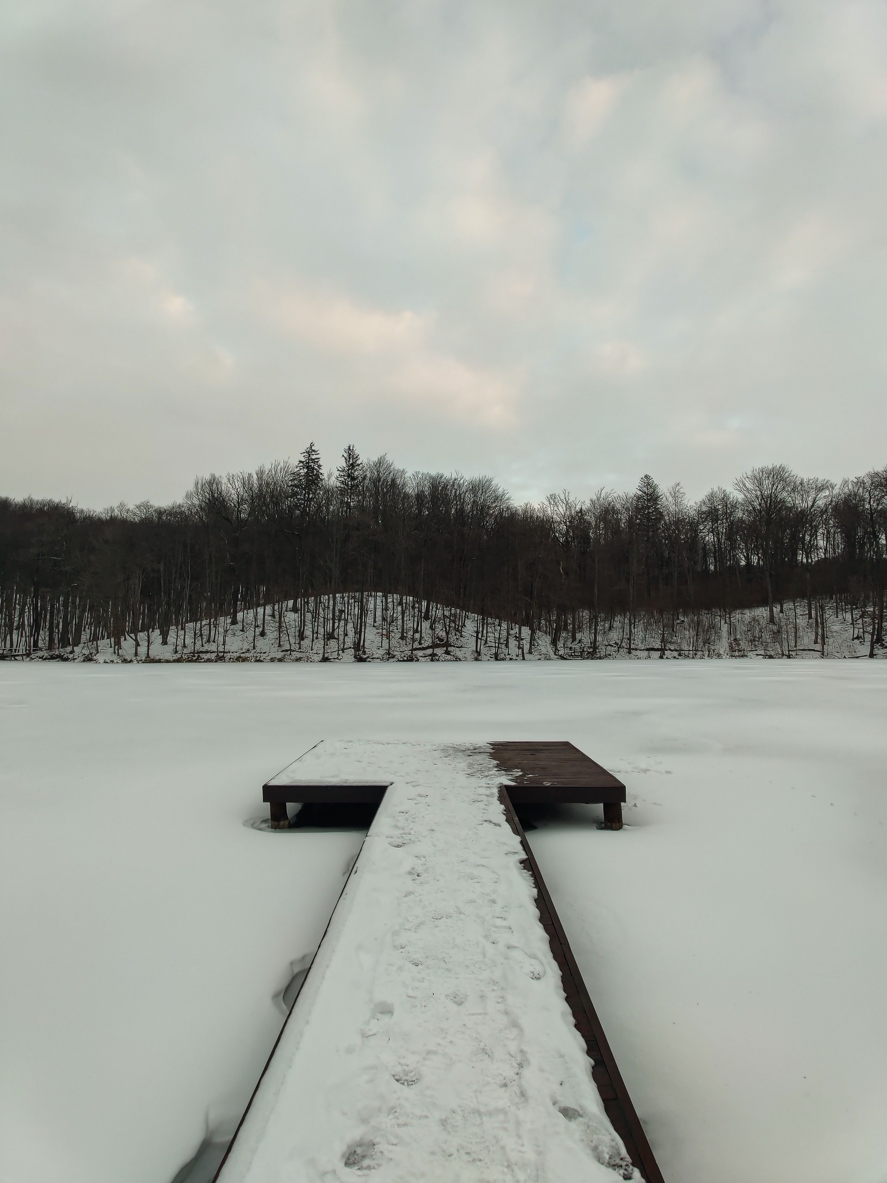 Snow Covered Jetty on a Frozen Lake · Free Stock Photo