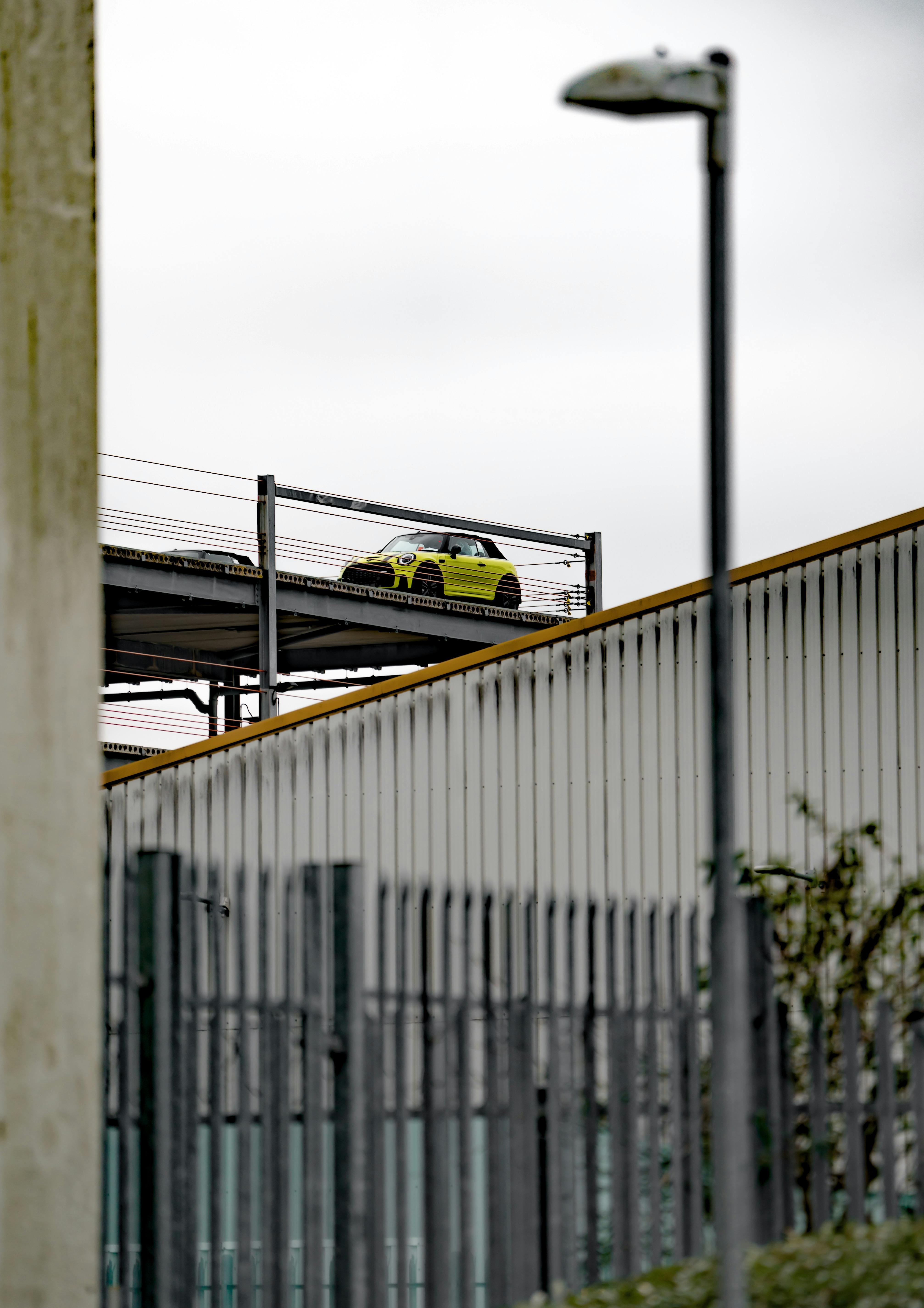 Yellow Mini Hatch on the Upper Floor of Parking Garage · Free Stock Photo