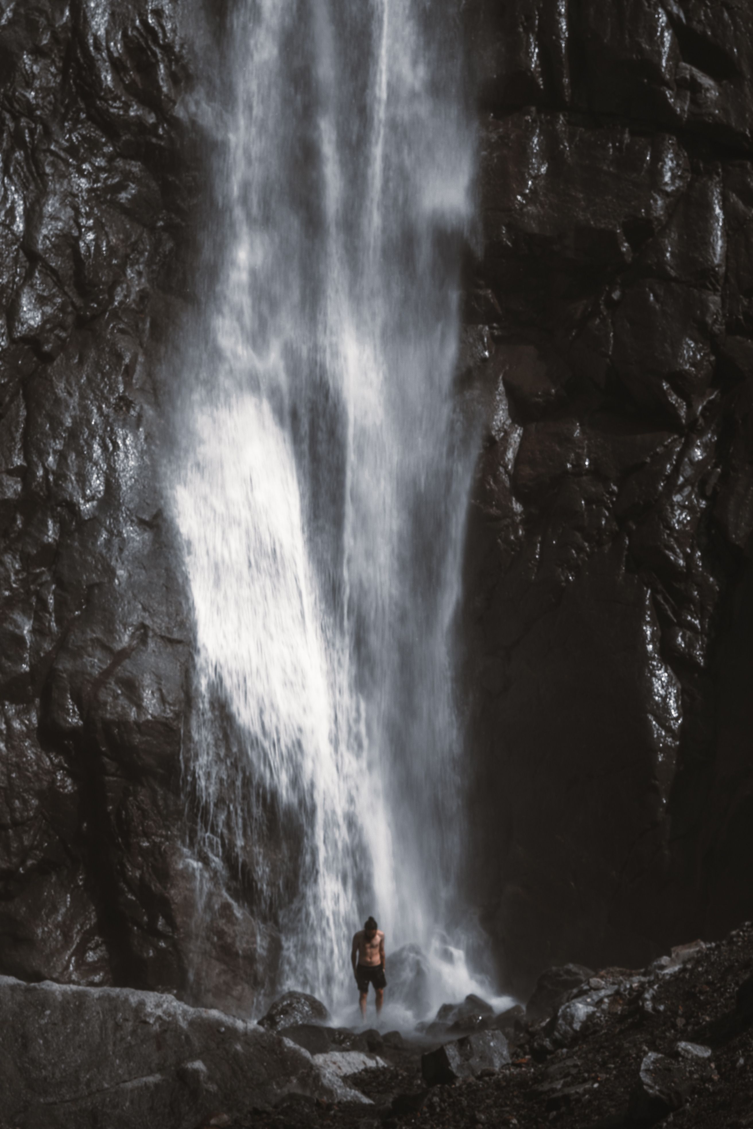 Man Standing under Waterfall · Free Stock Photo