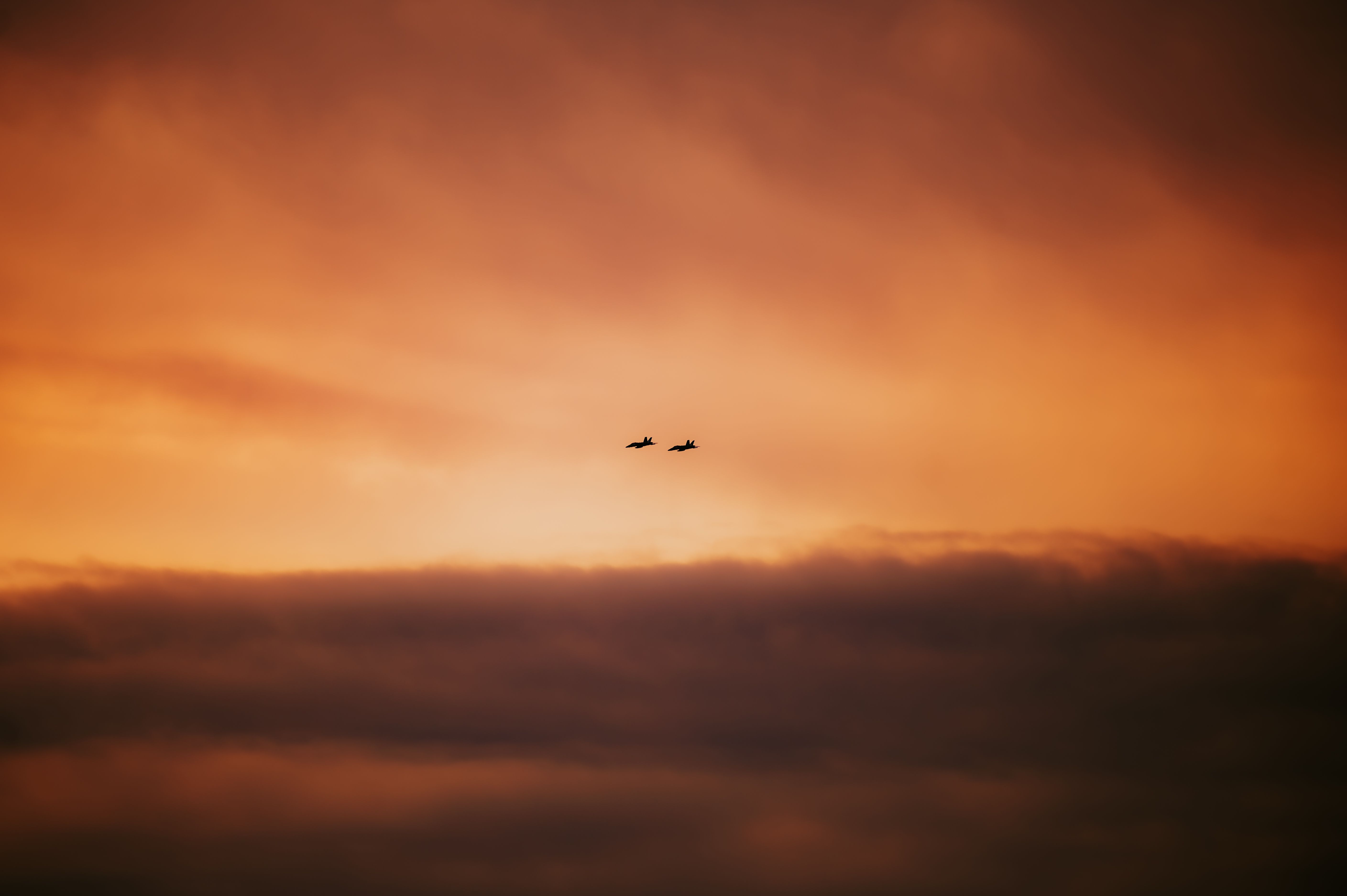 Two Fighter Jets Flying in Orange Sunset Sky · Free Stock Photo