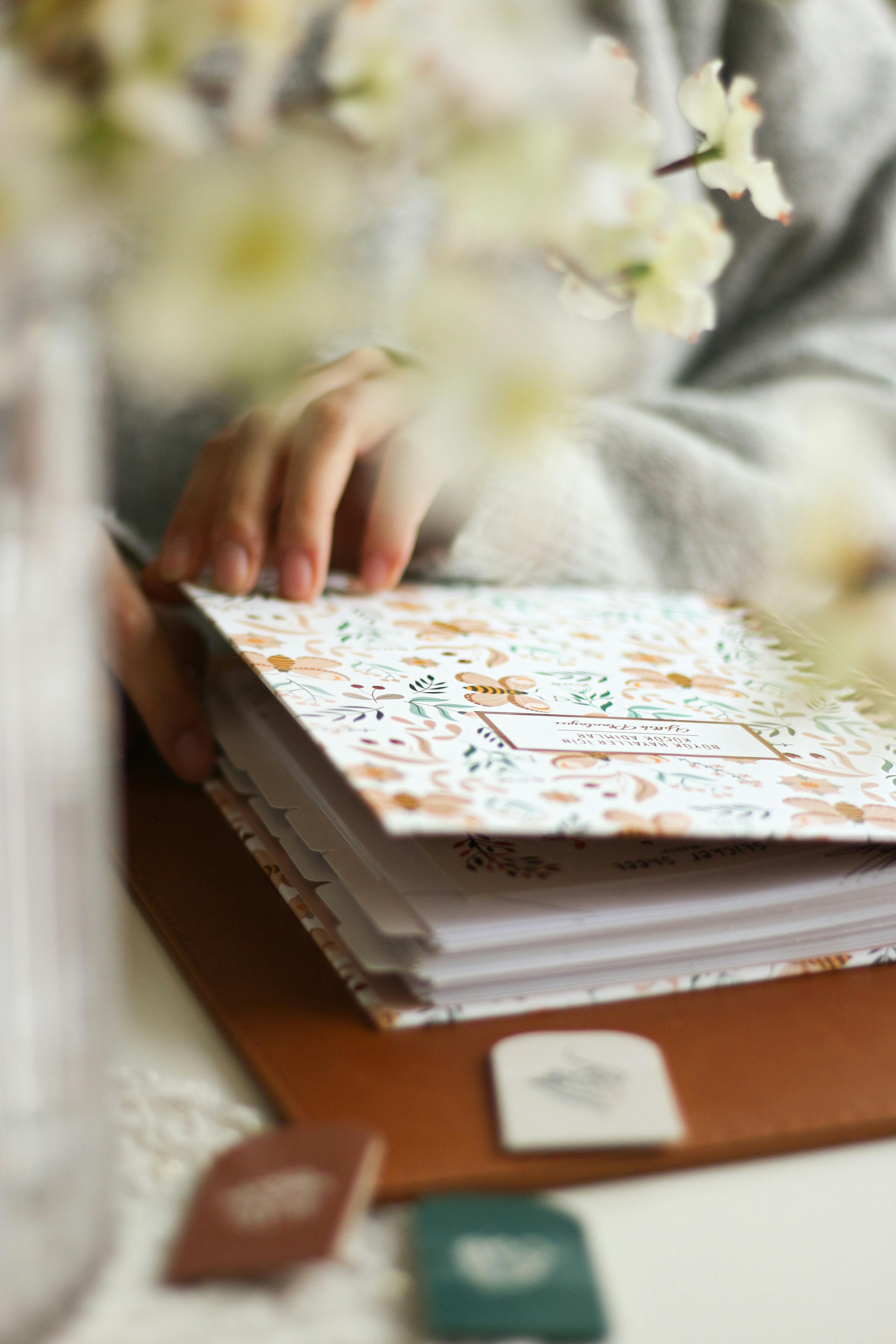 Close-up of Woman Opening a Notebook · Free Stock Photo
