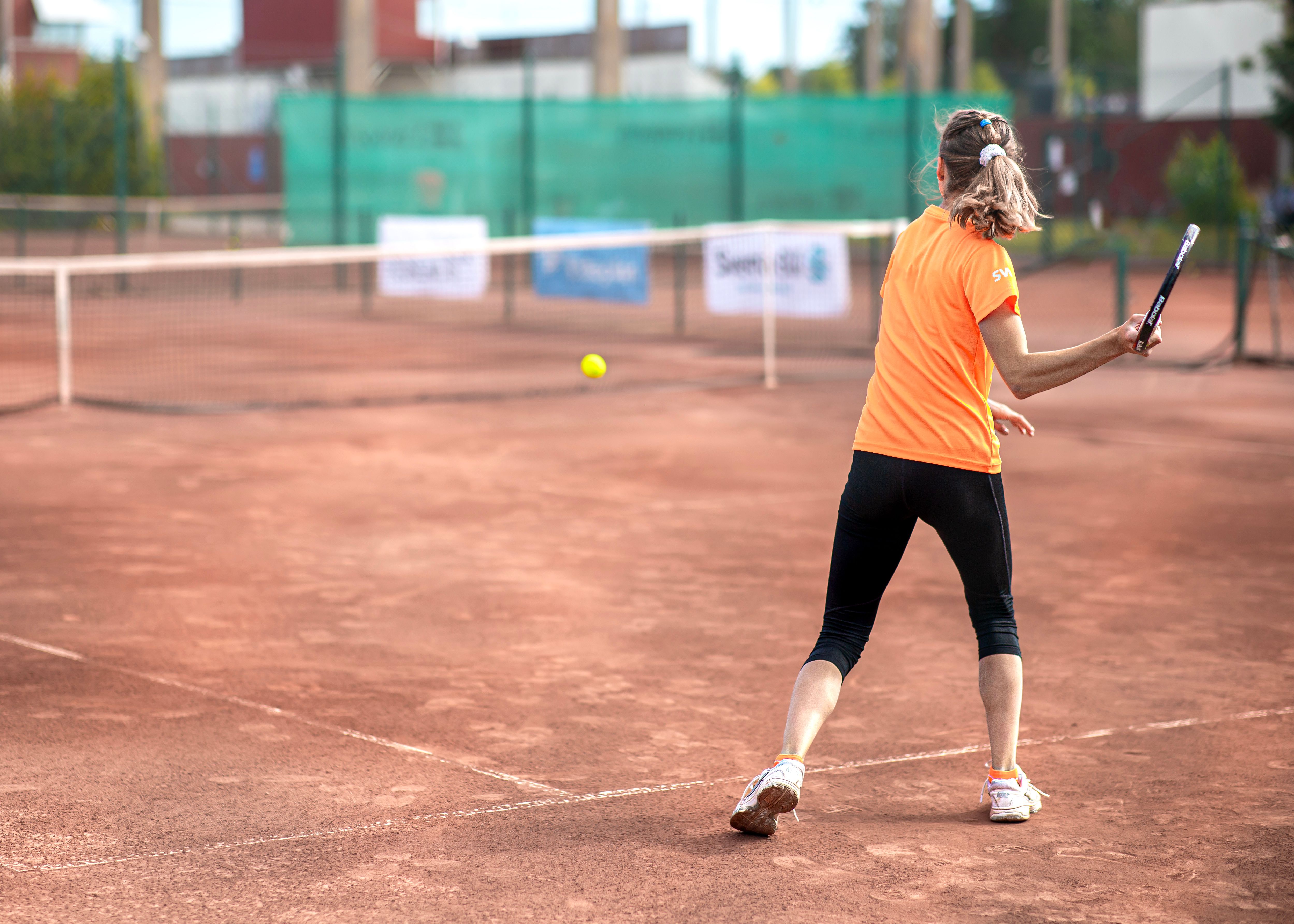 Man Playing Tennis on Court in Tropical Landscape · Free Stock Photo