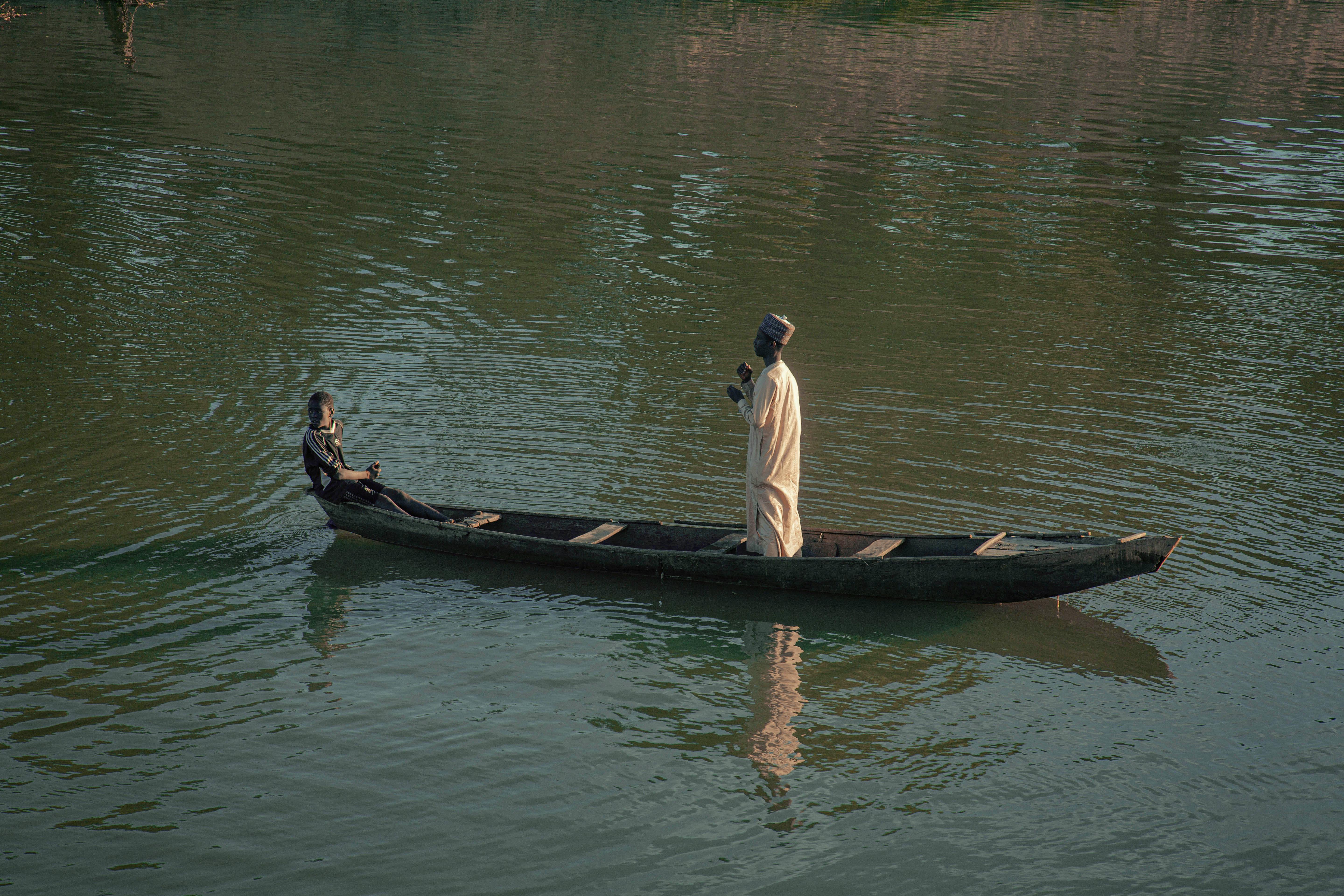 A man in a boat on a river · Free Stock Photo