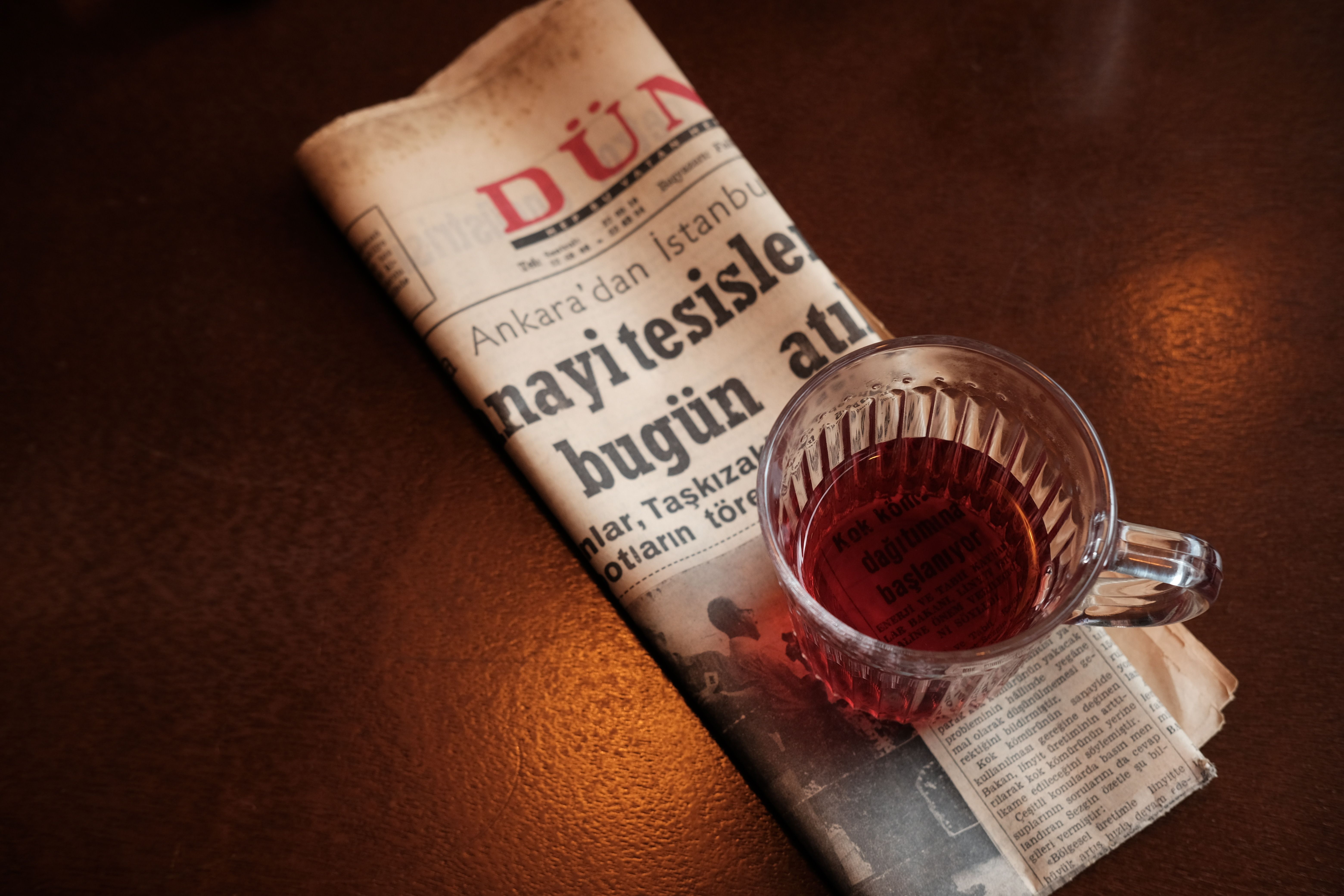 A Cup of Tea Standing on a Newspaper · Free Stock Photo