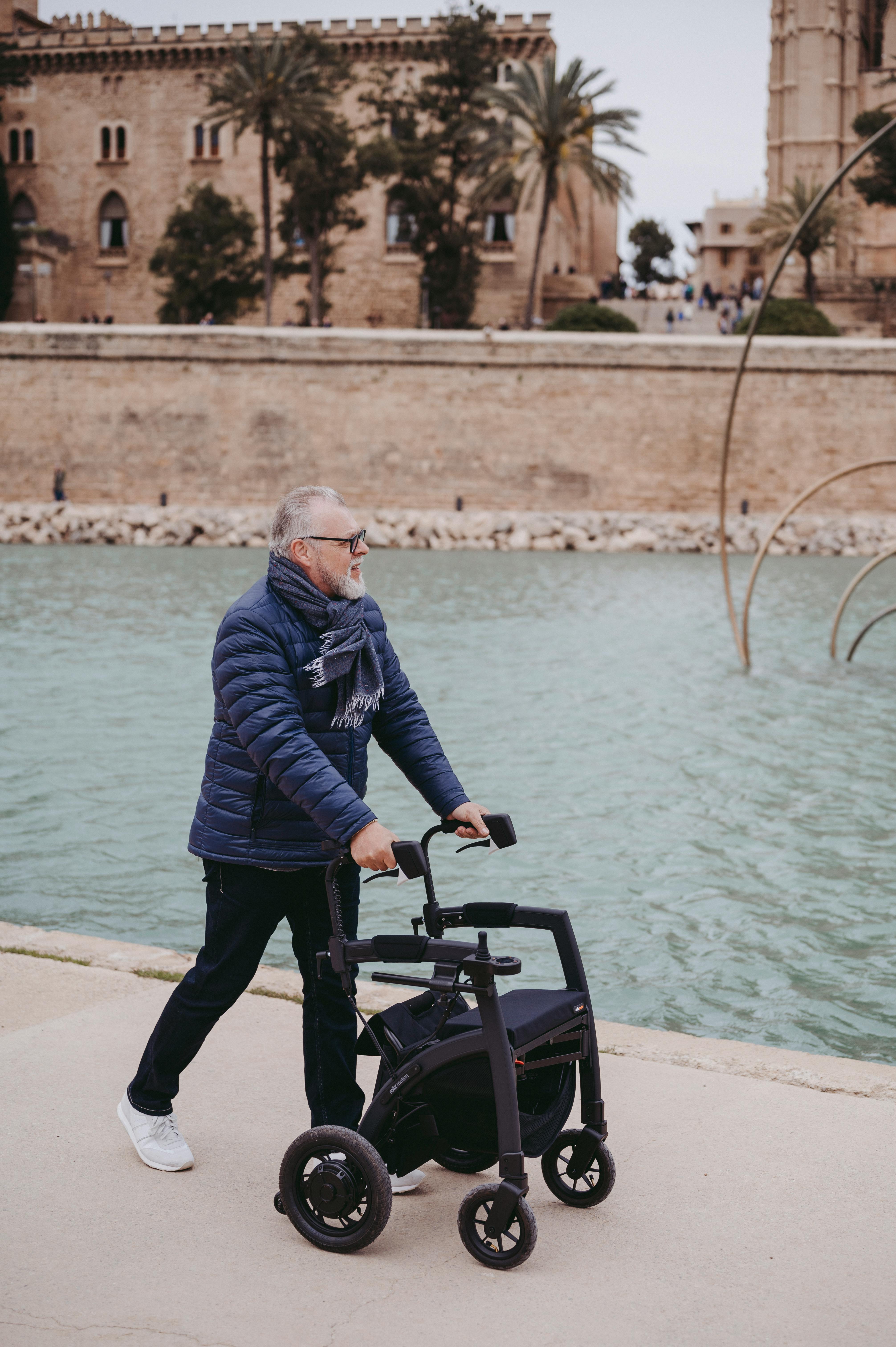 Elderly man walking with a rollator walker · Free Stock Photo
