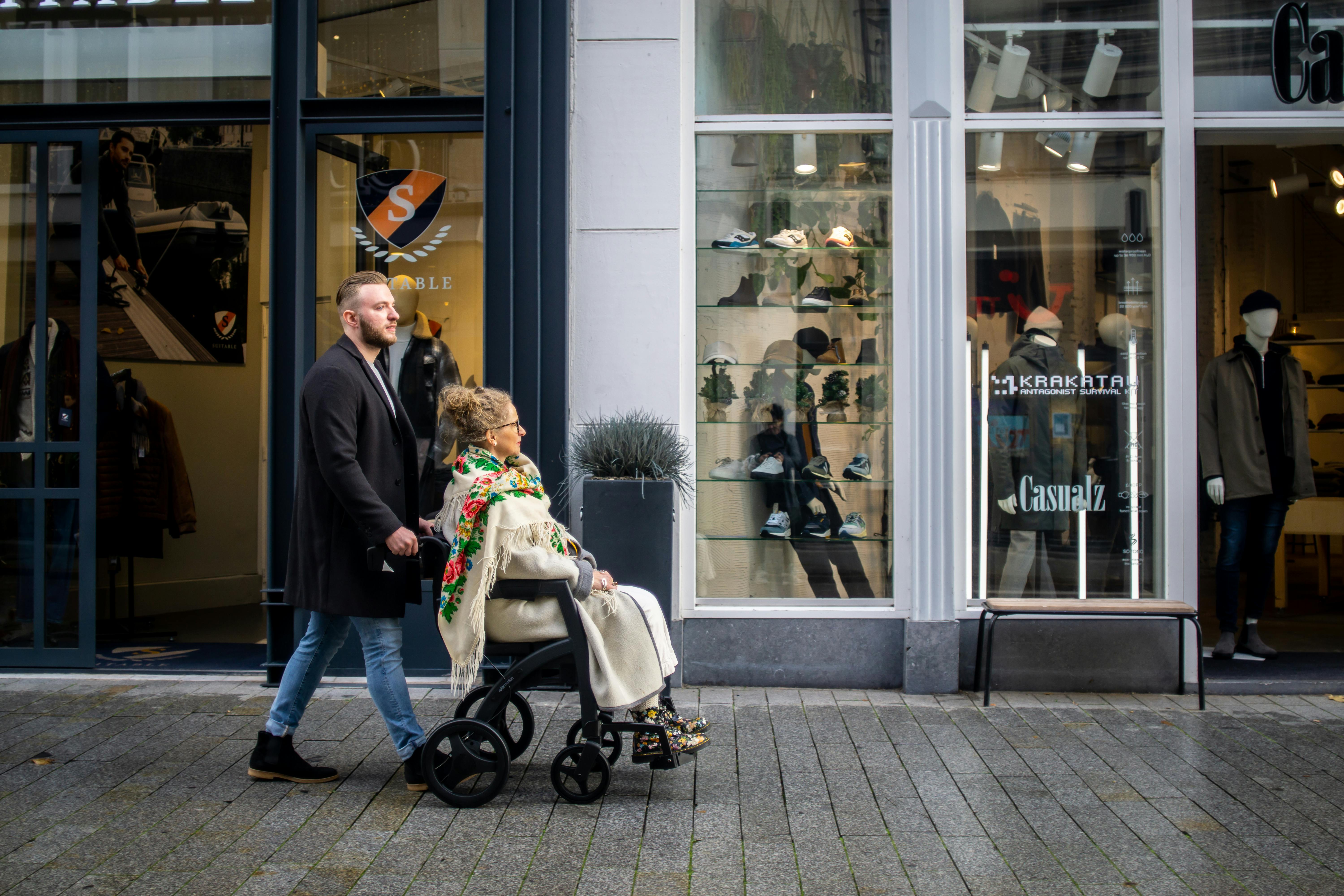 Man Pulling Woman in Wheelchair · Free Stock Photo