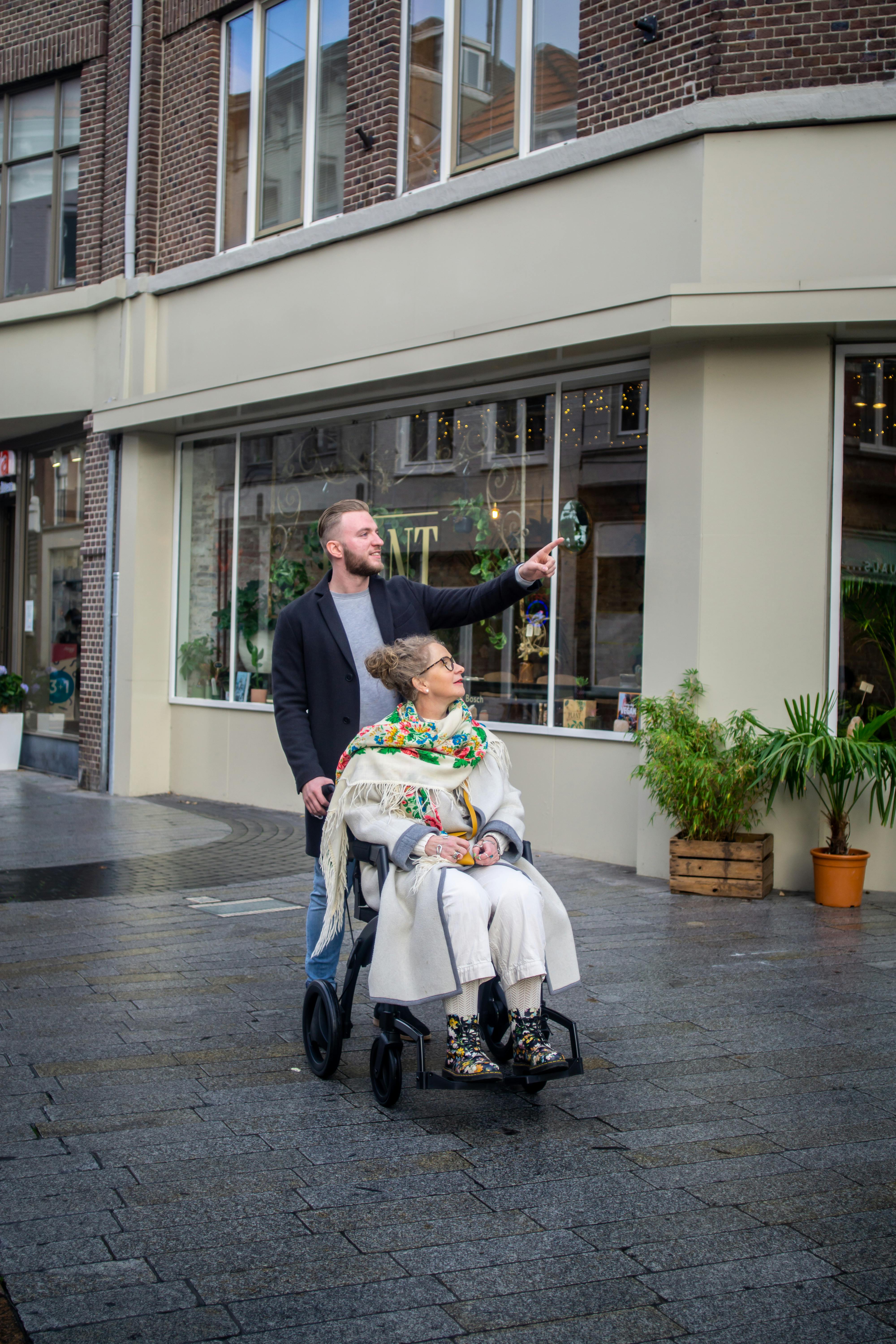 Man pushing elderly lady on a wheelchair · Free Stock Photo