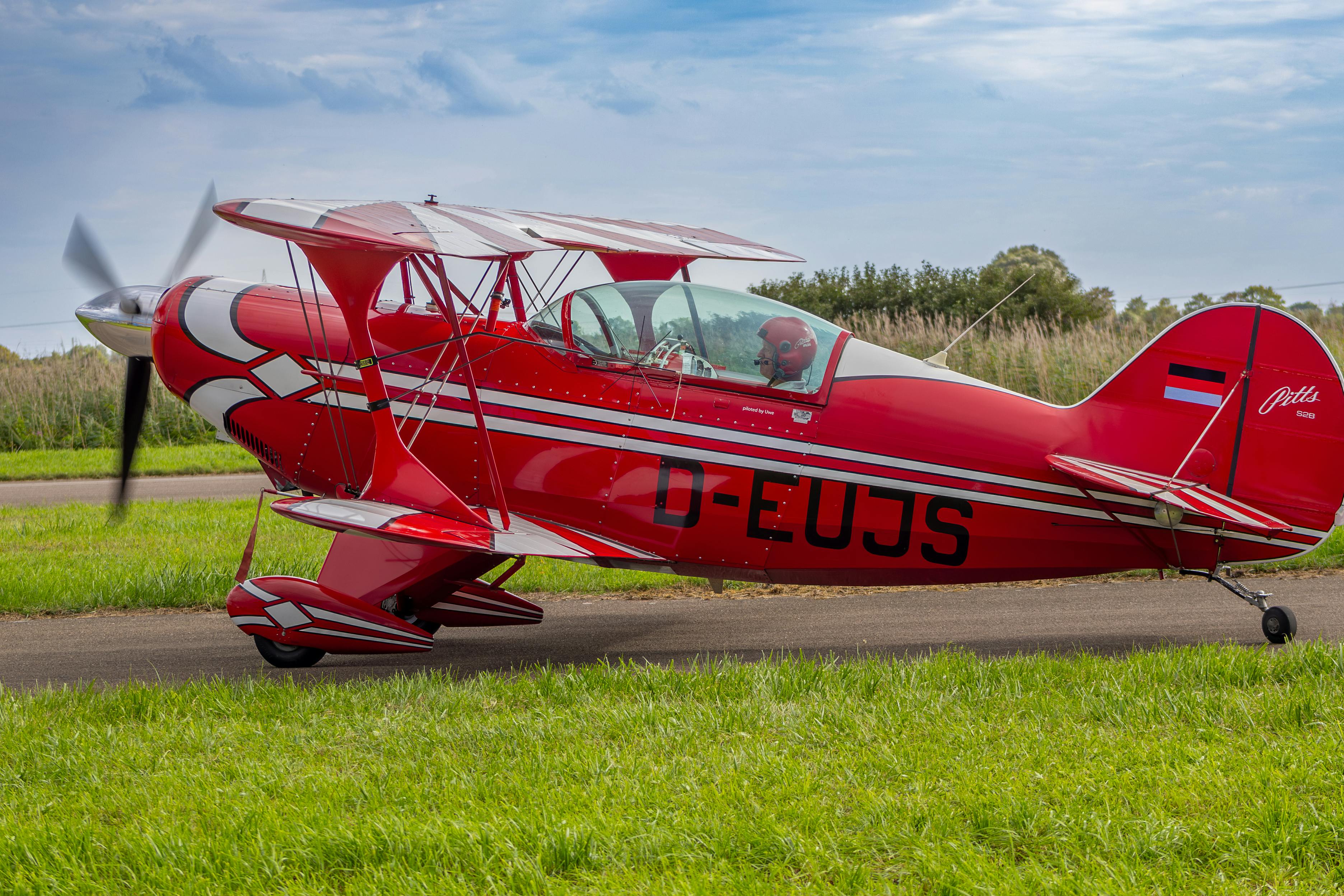 Red Biplane on Tarmac · Free Stock Photo