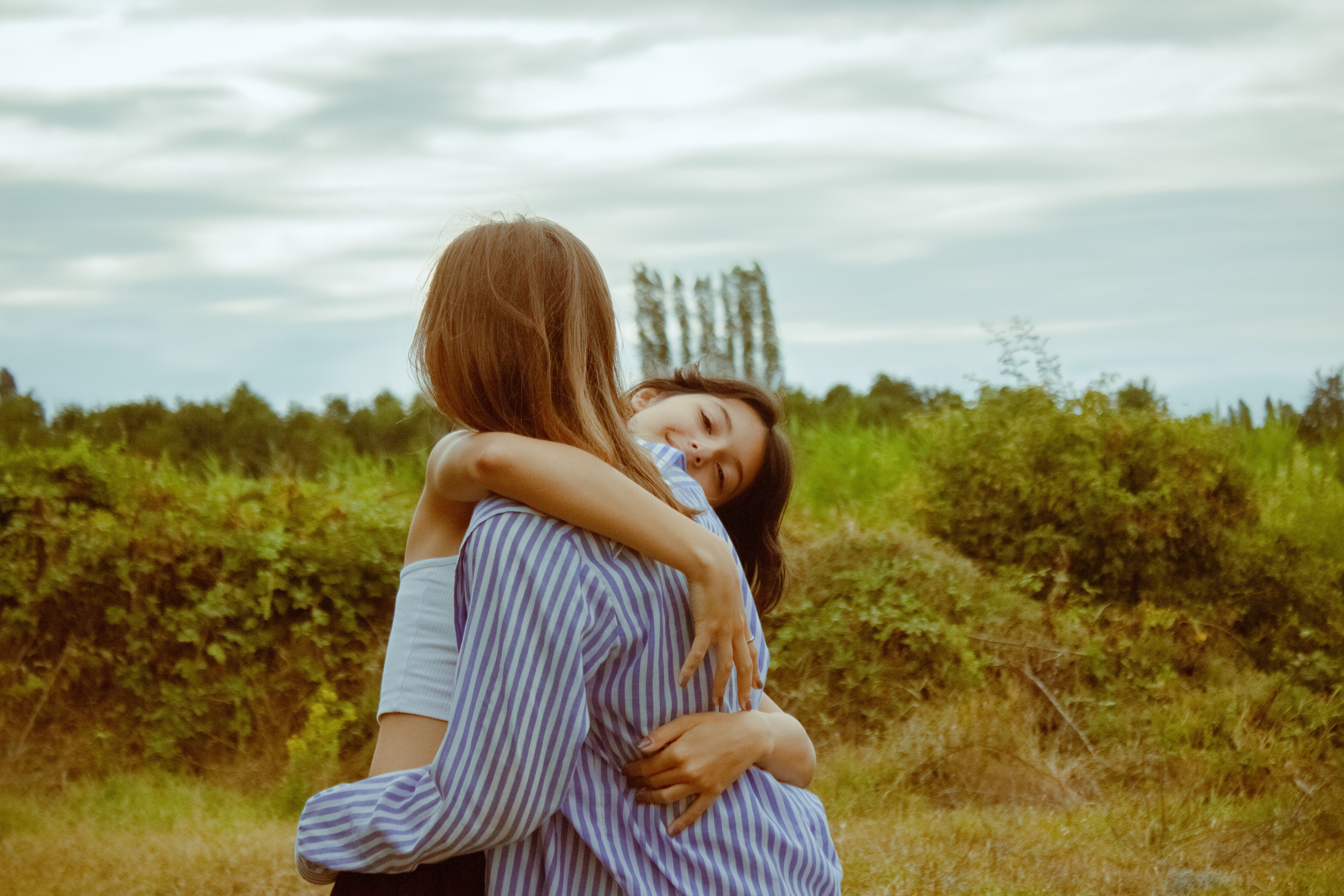 Women Hugging on Field · Free Stock Photo