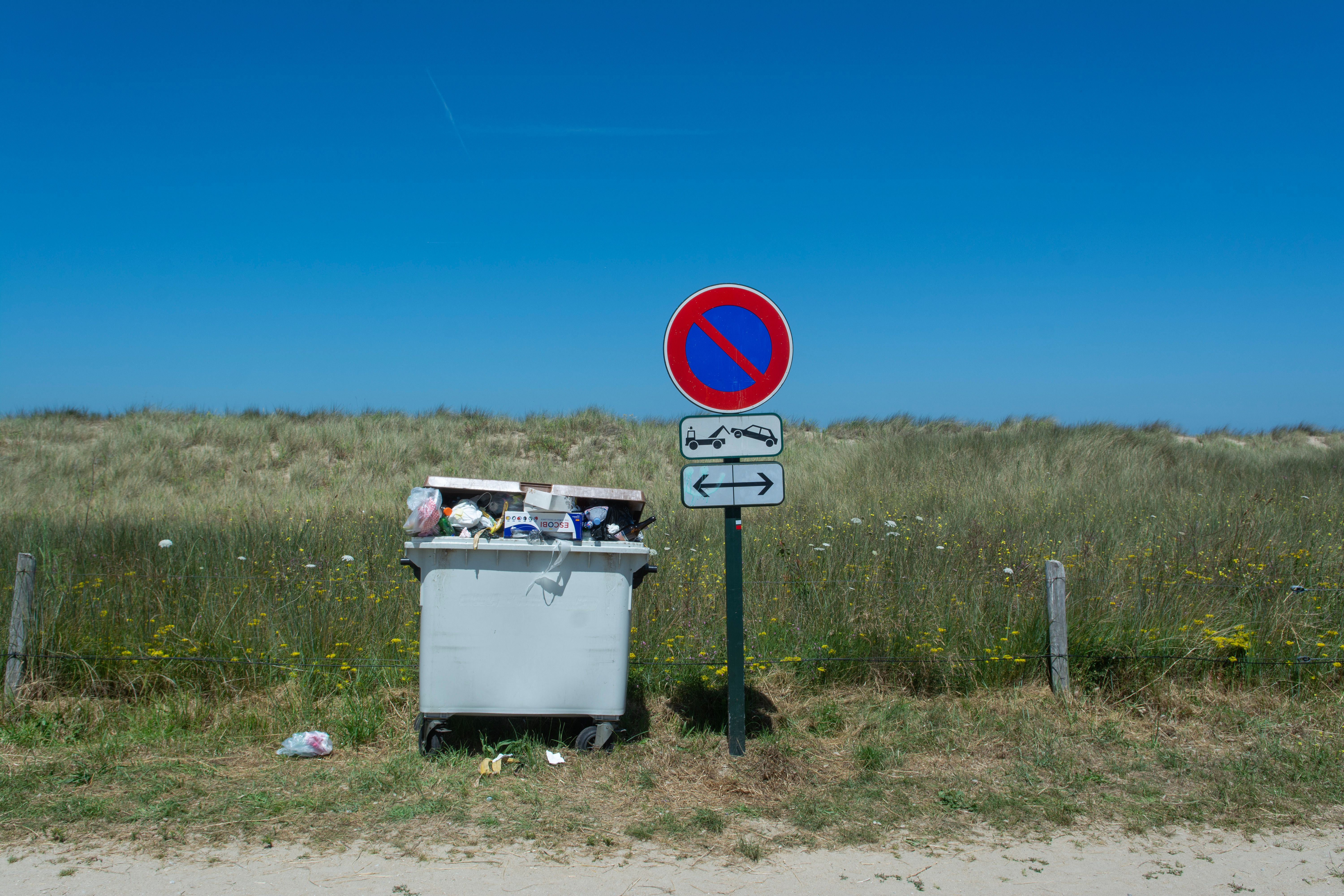 Road Sign and Garbage Bin in Countryside · Free Stock Photo