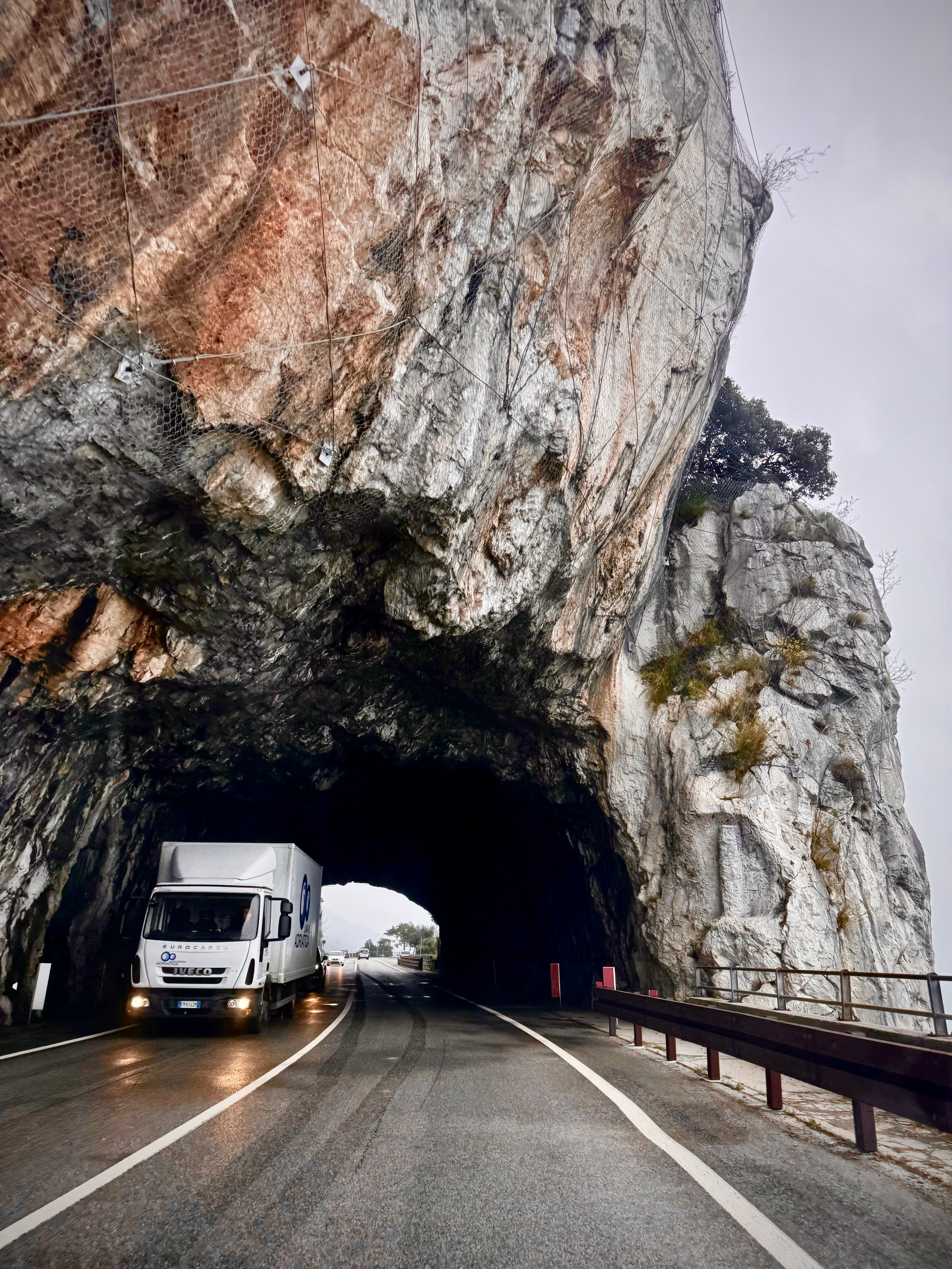 Truck Drive under Rock Arch · Free Stock Photo