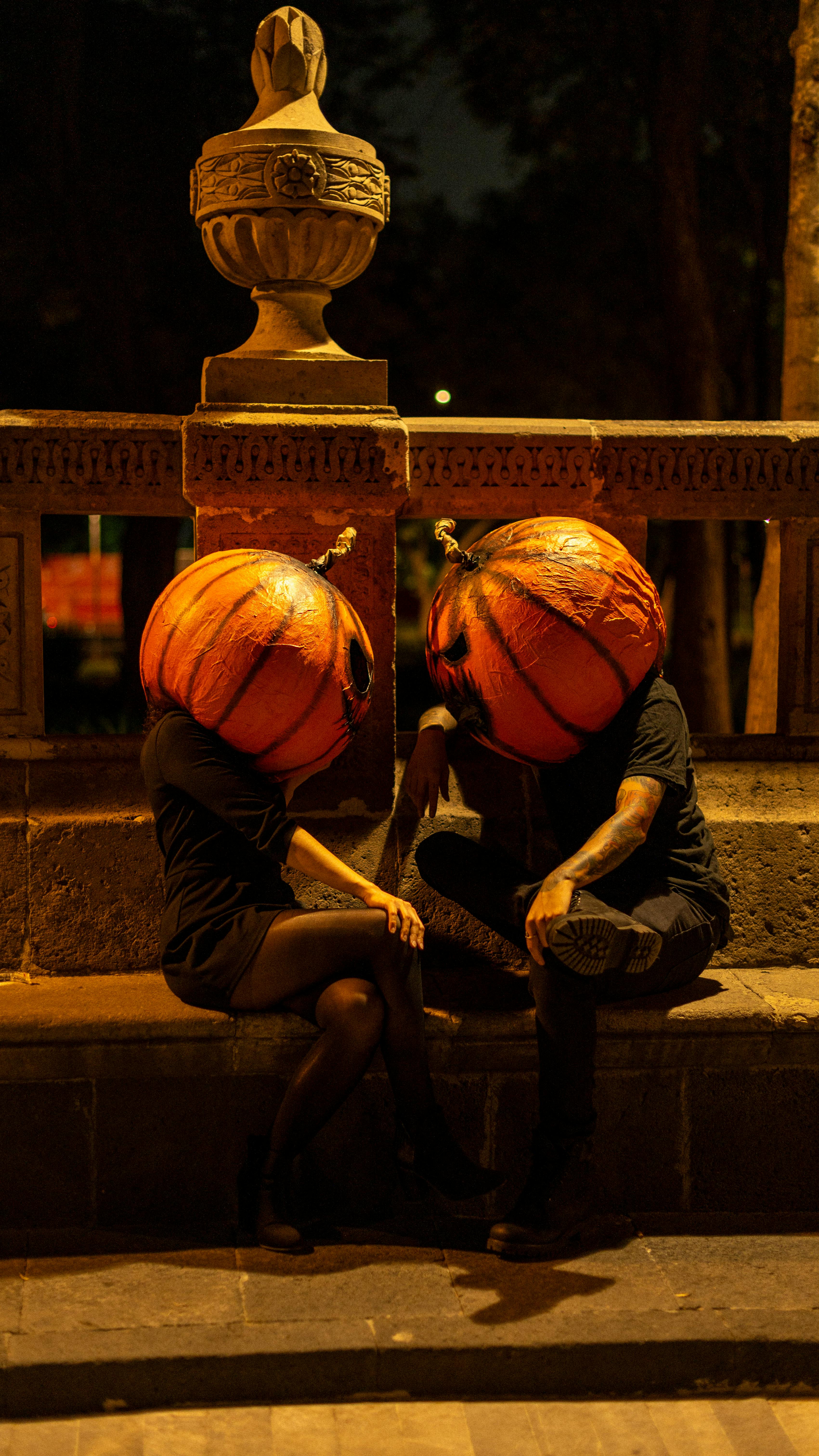 Couple Wear Pumpkin on Heads Sit on Step · Free Stock Photo