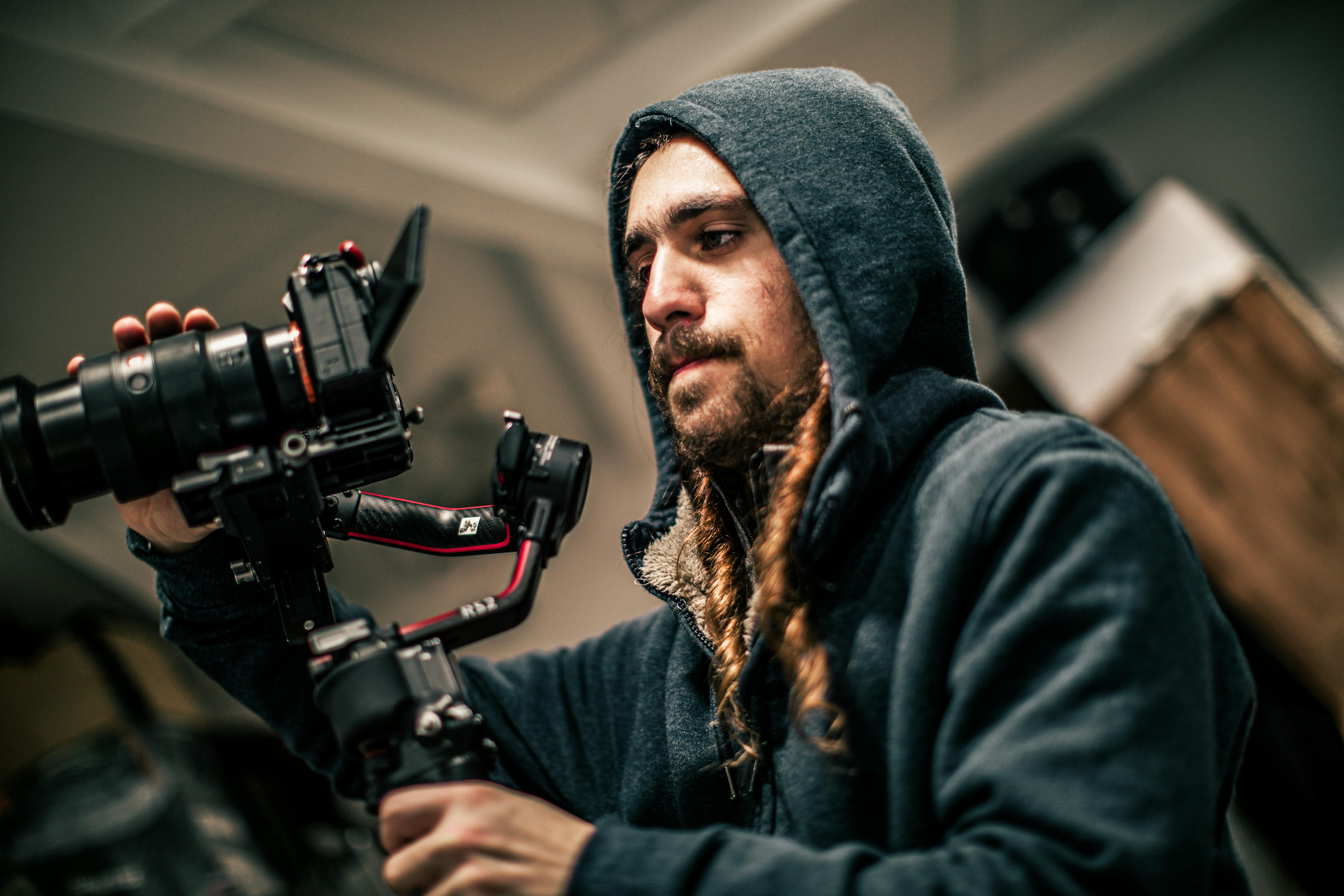 Cameraman Operating Digital Camera · Free Stock Photo