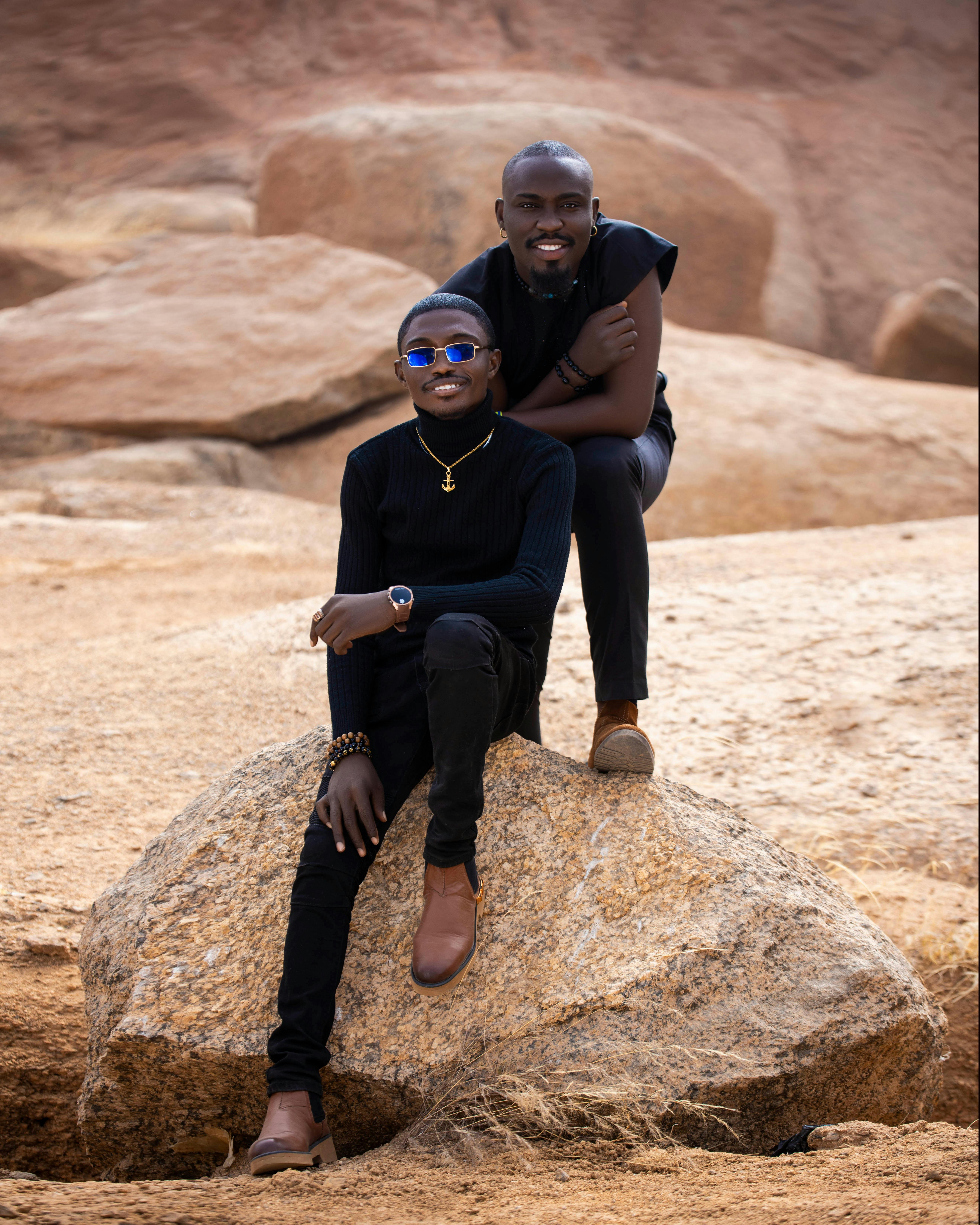 Men Posing on Rocks · Free Stock Photo
