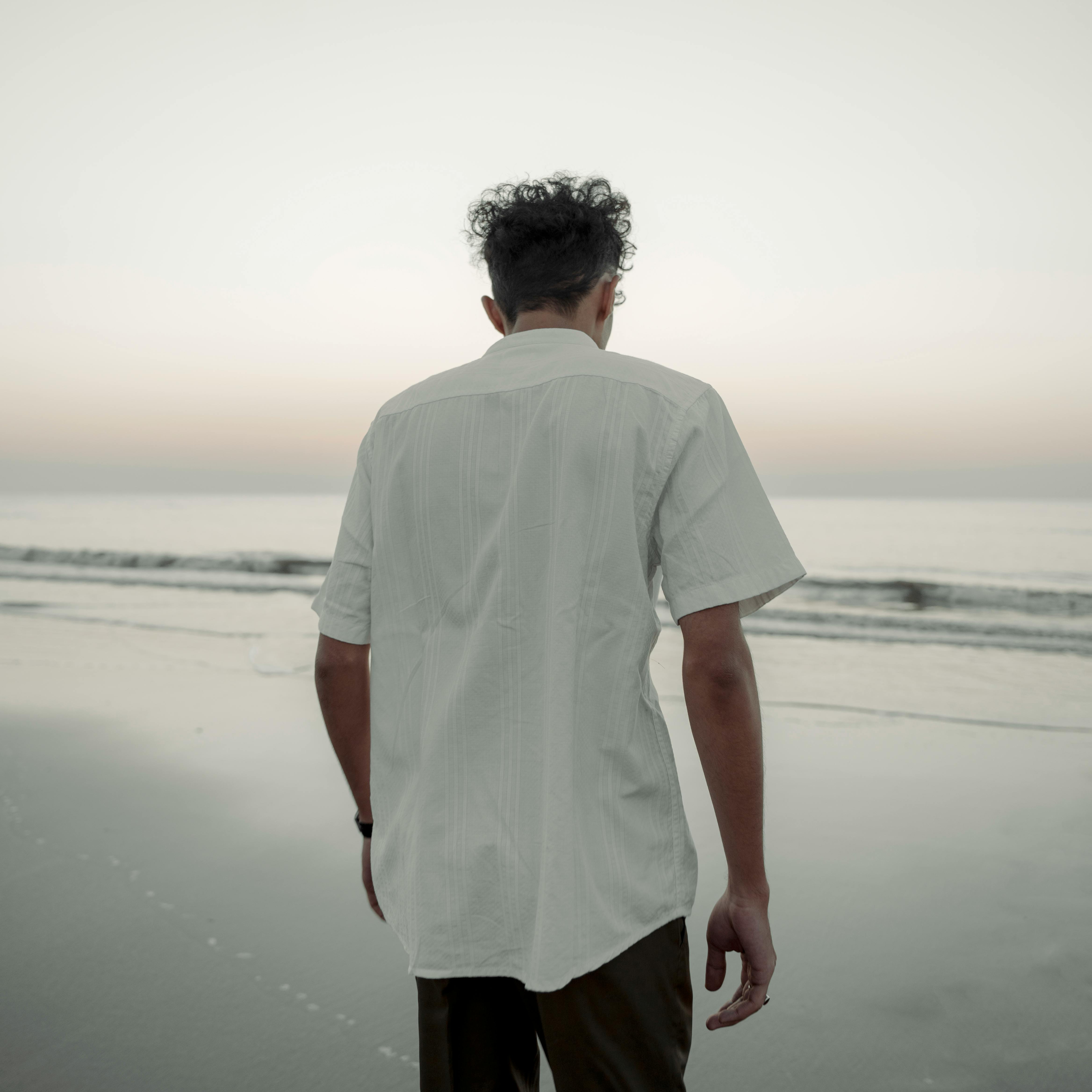 Back View of Man on Sea Shore · Free Stock Photo