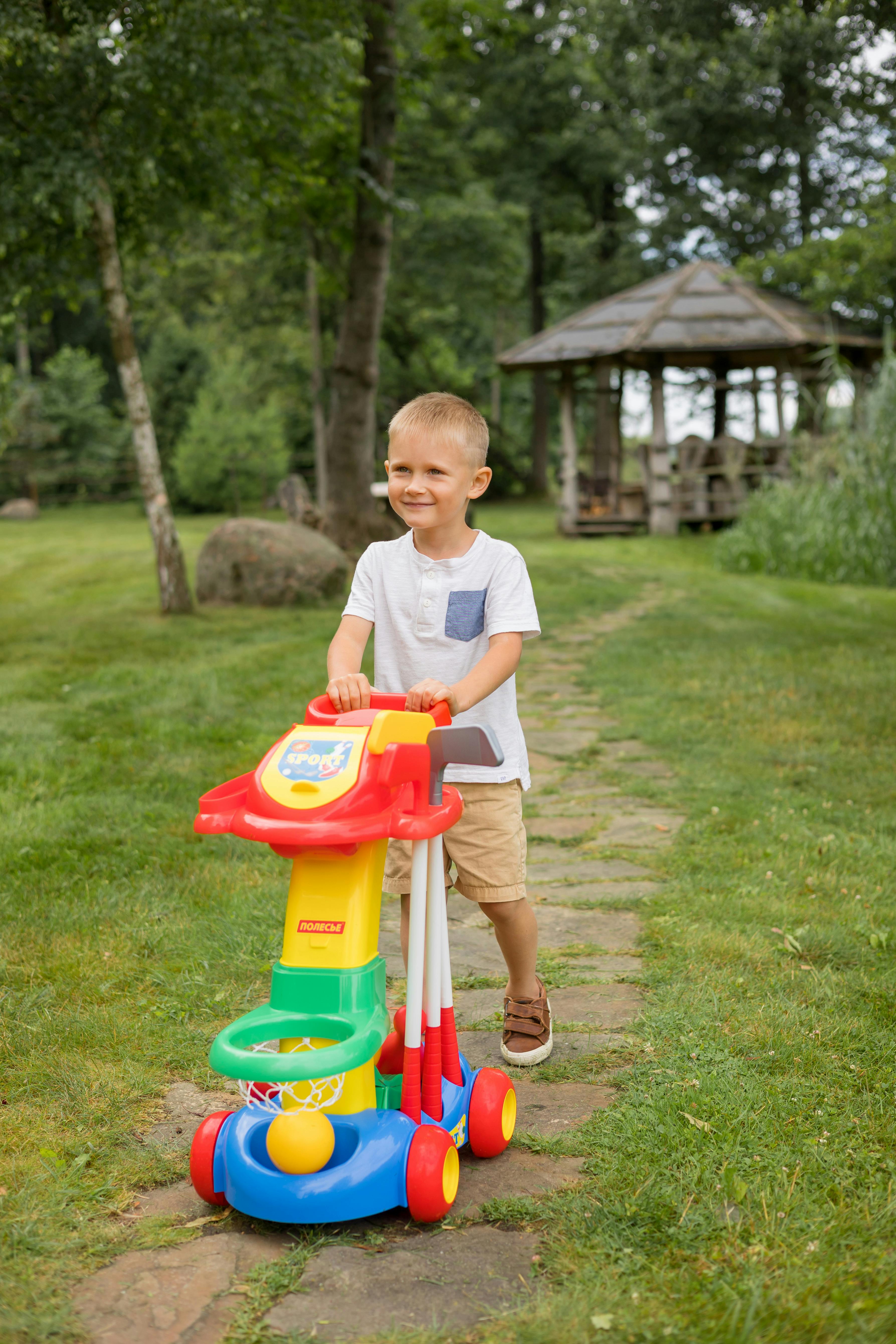 Boy Walking with Toy Trailer · Free Stock Photo