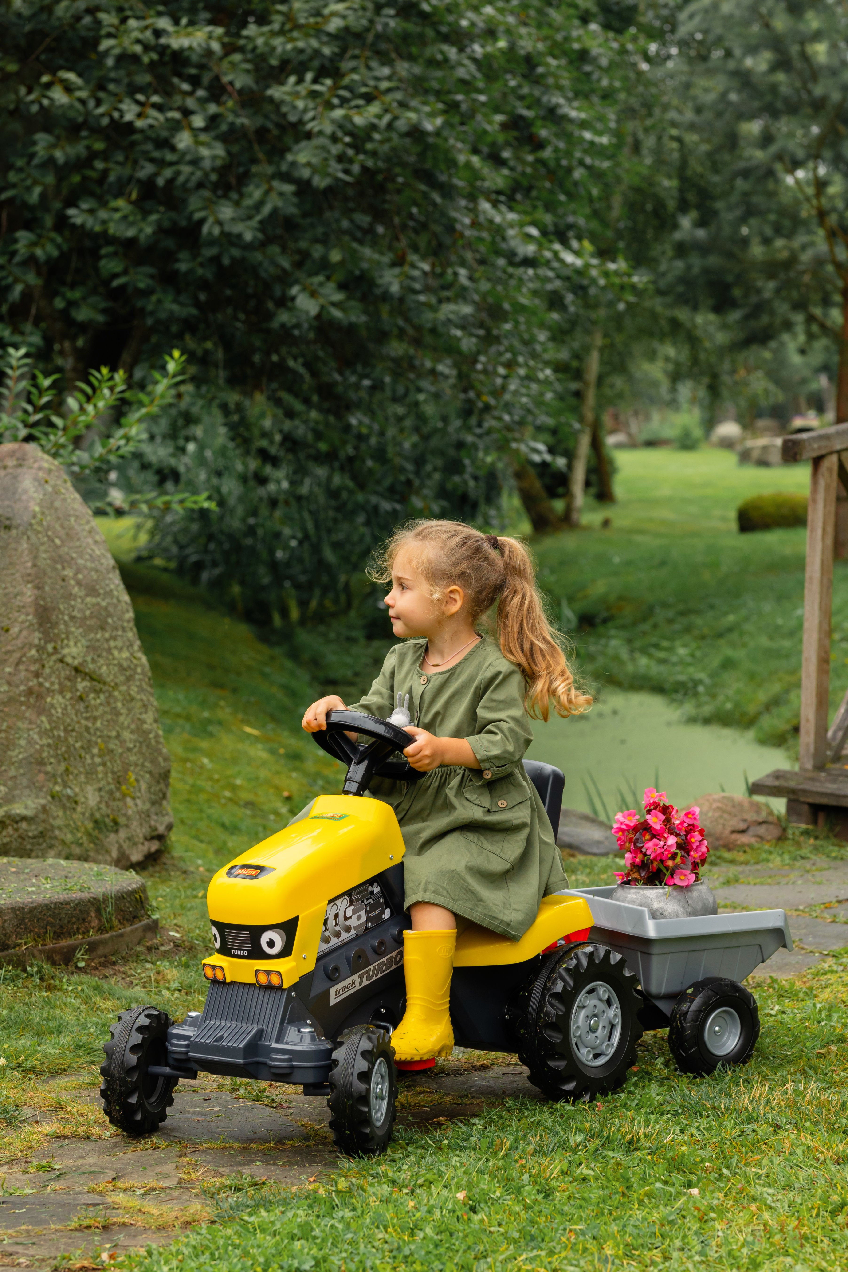 Girl Driving Toy Tractor · Free Stock Photo