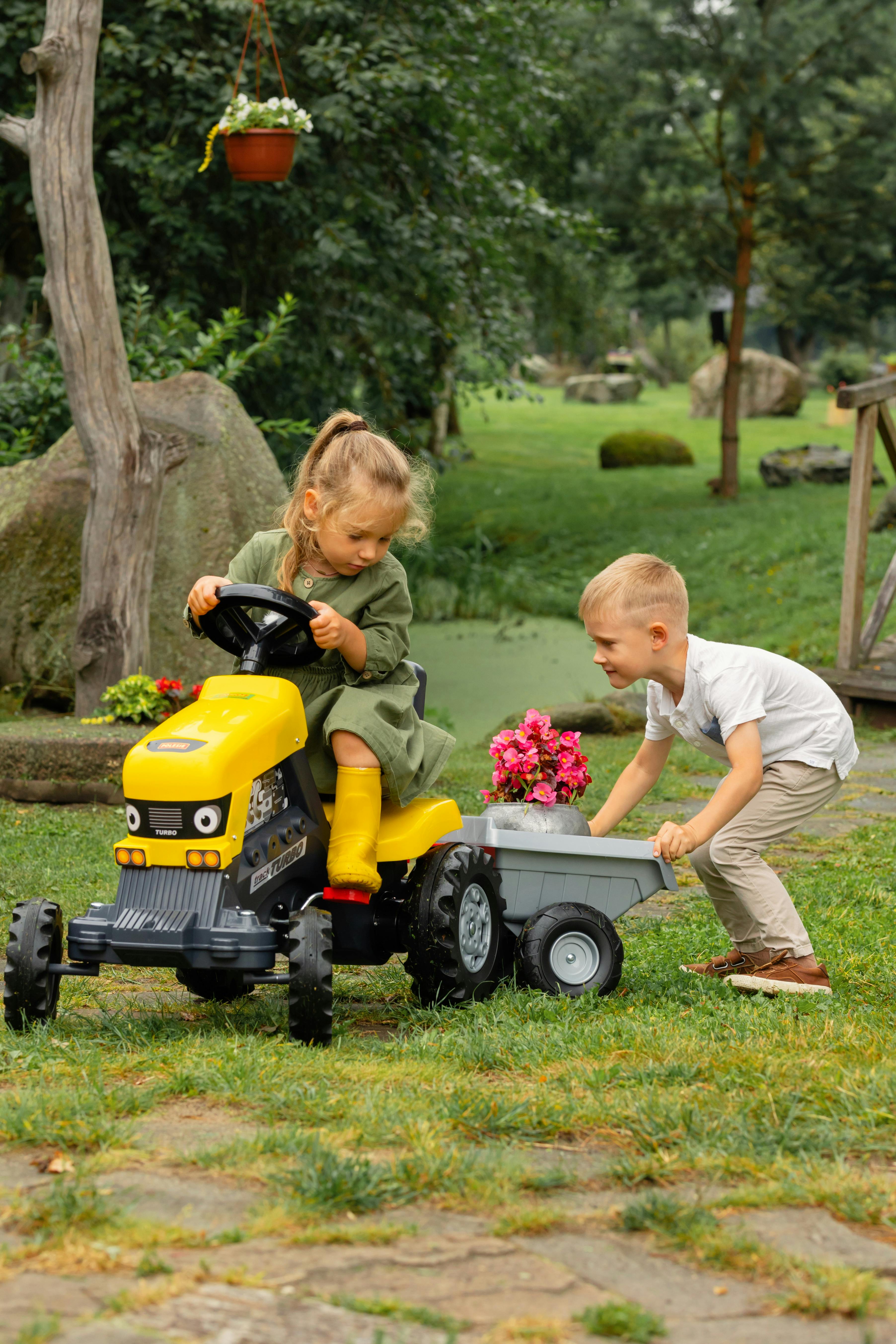 Siblings Playing with Toy Tractor · Free Stock Photo