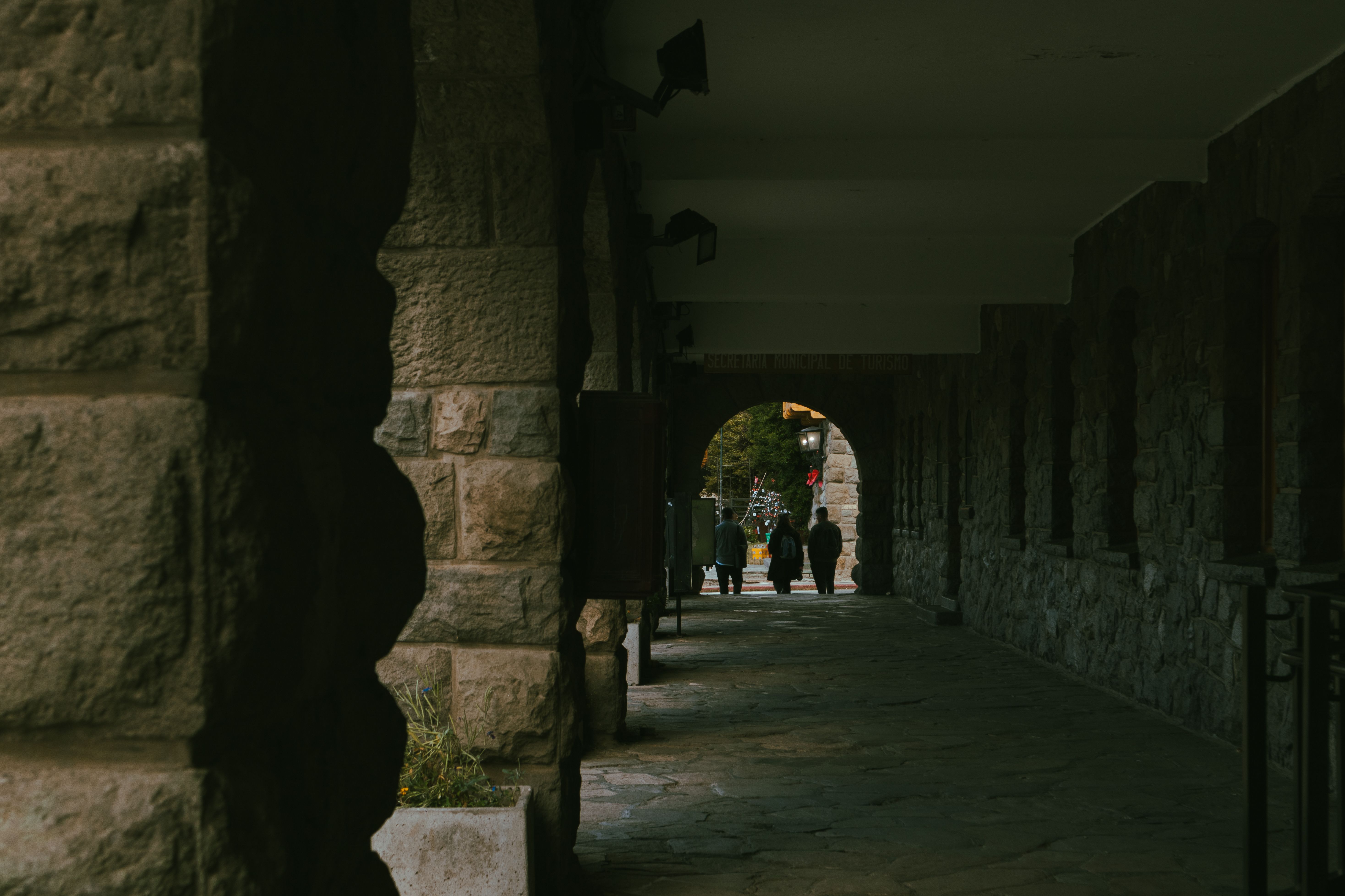 View of Pedestrians Walking under an Arch of a Stone Building · Free ...