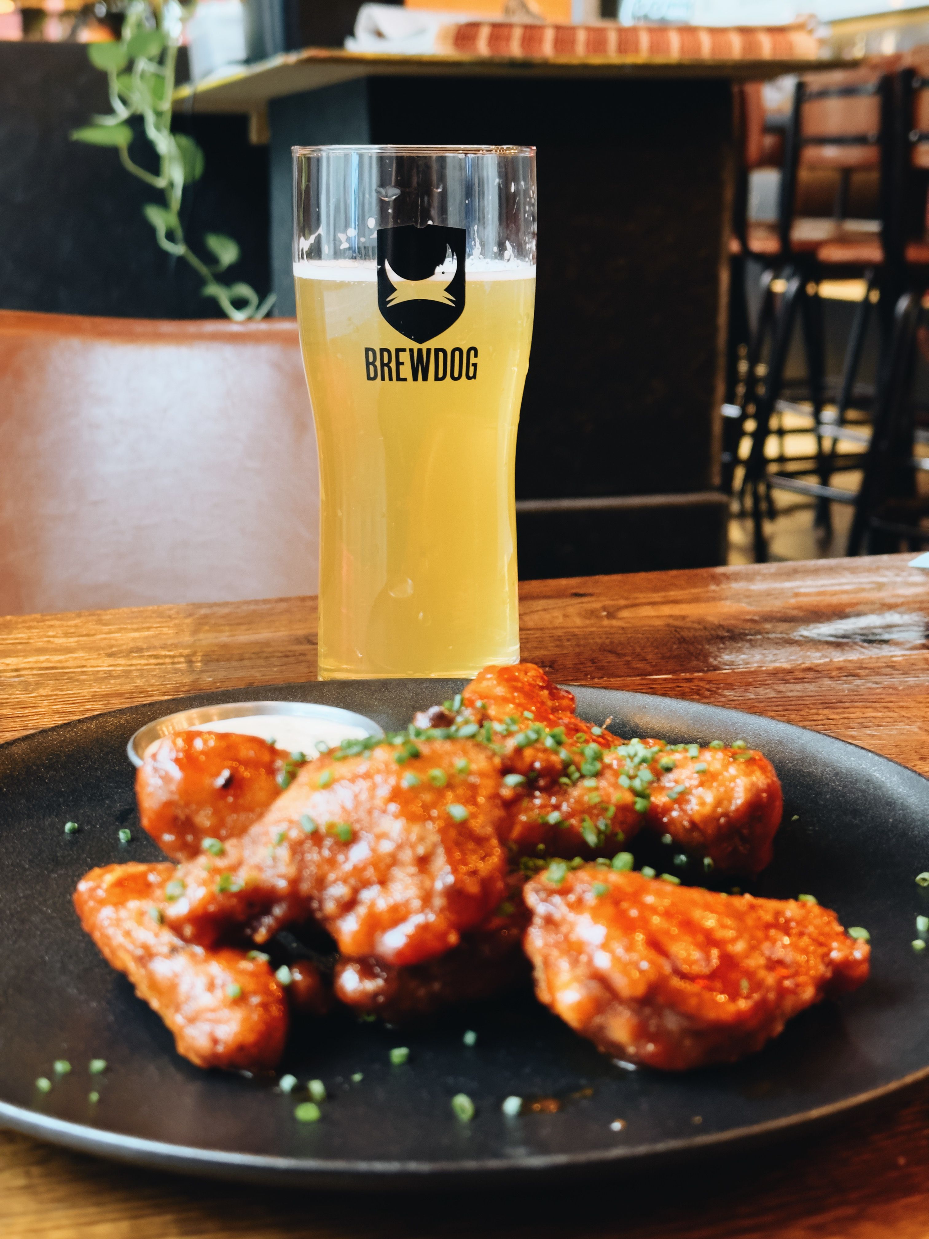Glass of BrewDog Beer with Chicken Legs · Free Stock Photo