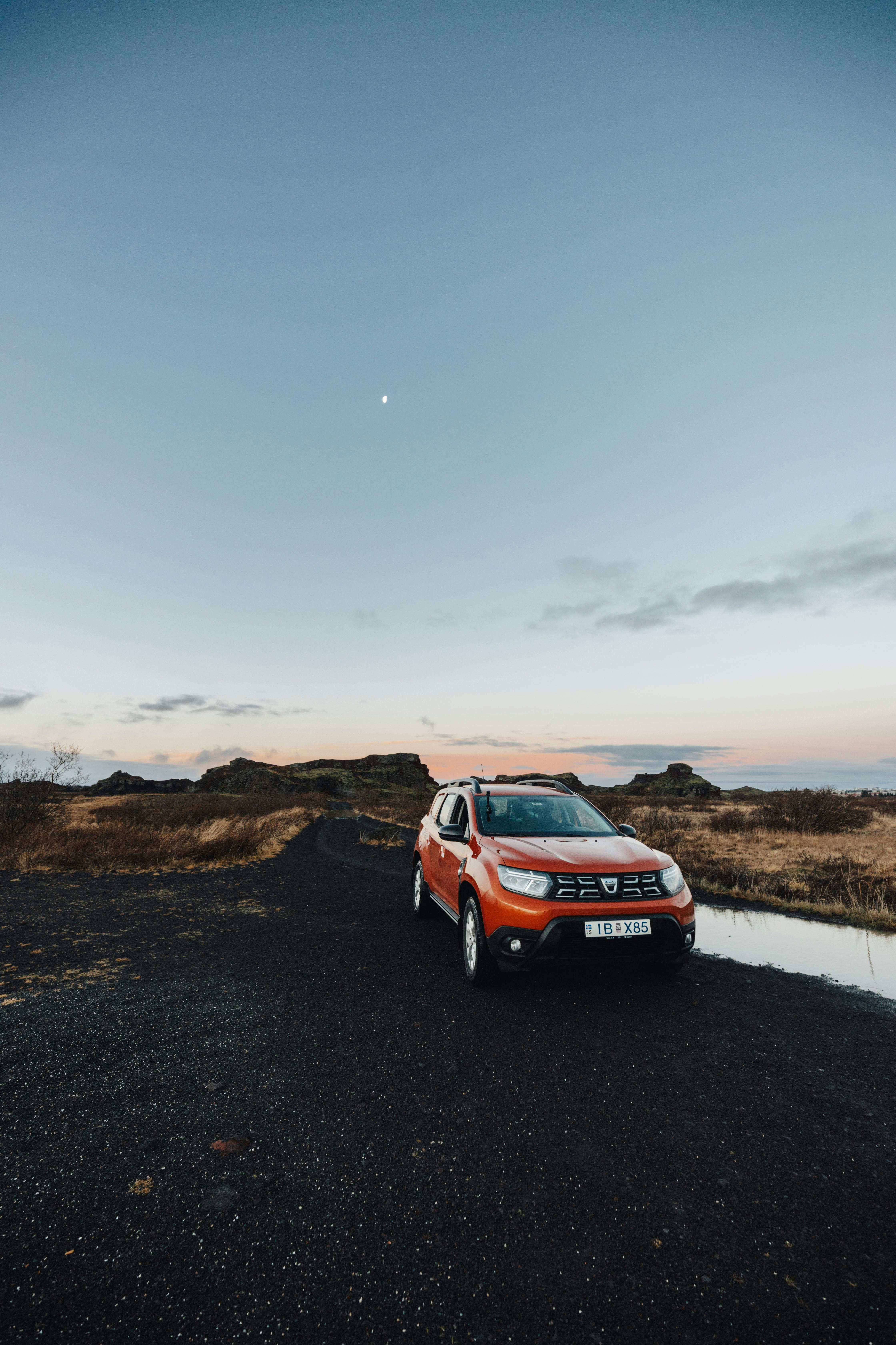 Dacia Duster on an Asphalt Country Road in the Evening · Free Stock Photo