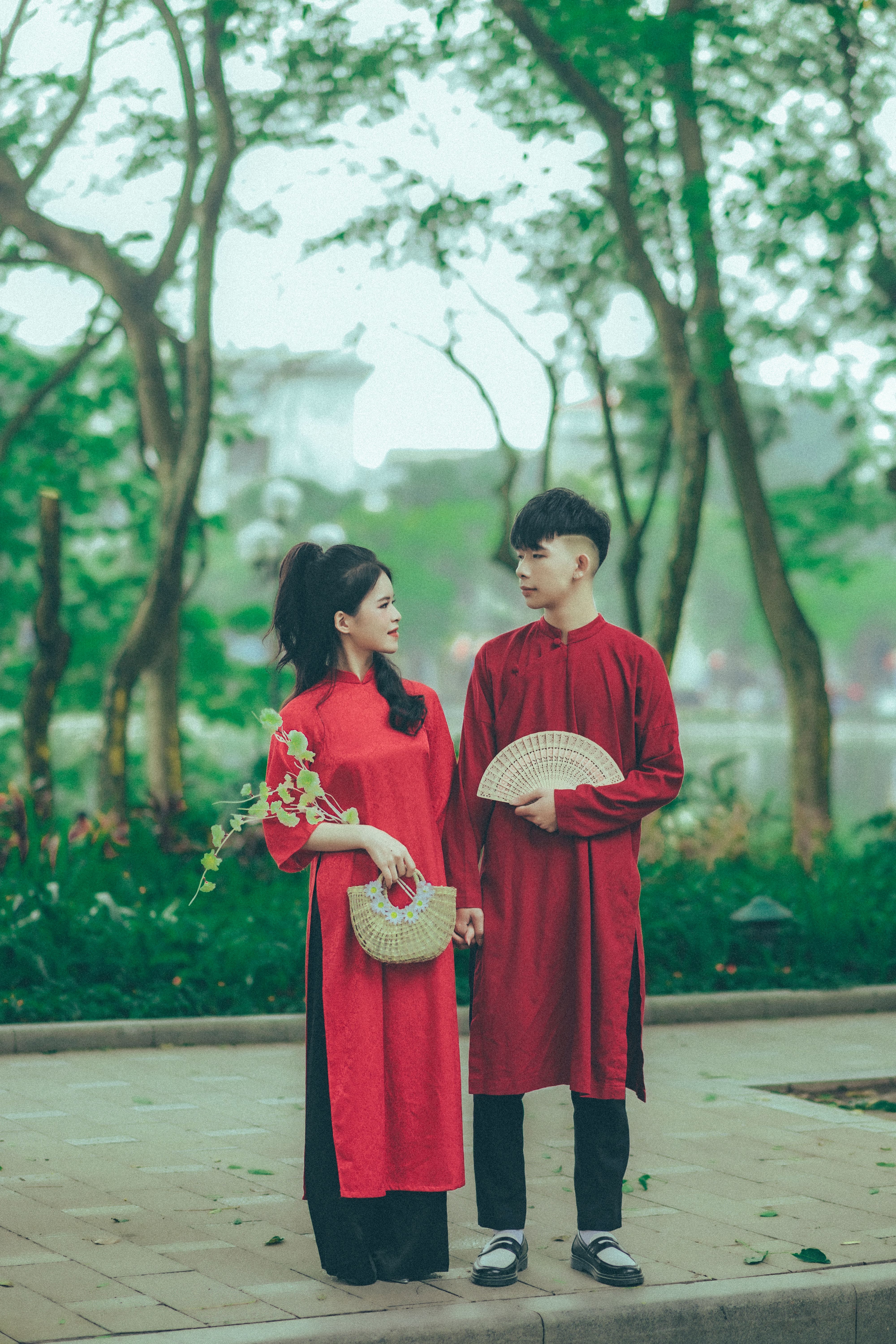 Couple Wearing Red Gowns in a Park · Free Stock Photo