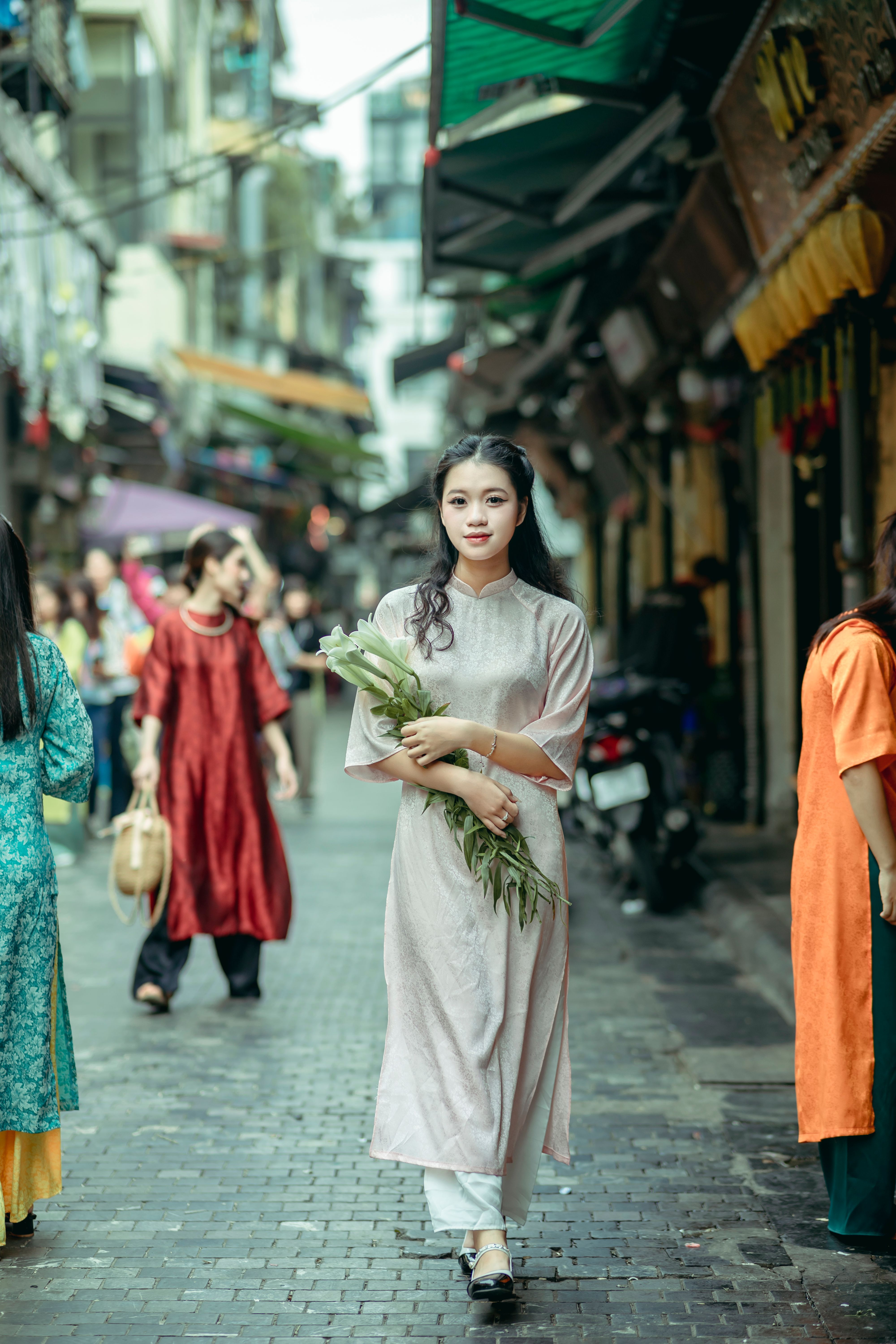 Woman Walking in Traditional Clothing · Free Stock Photo