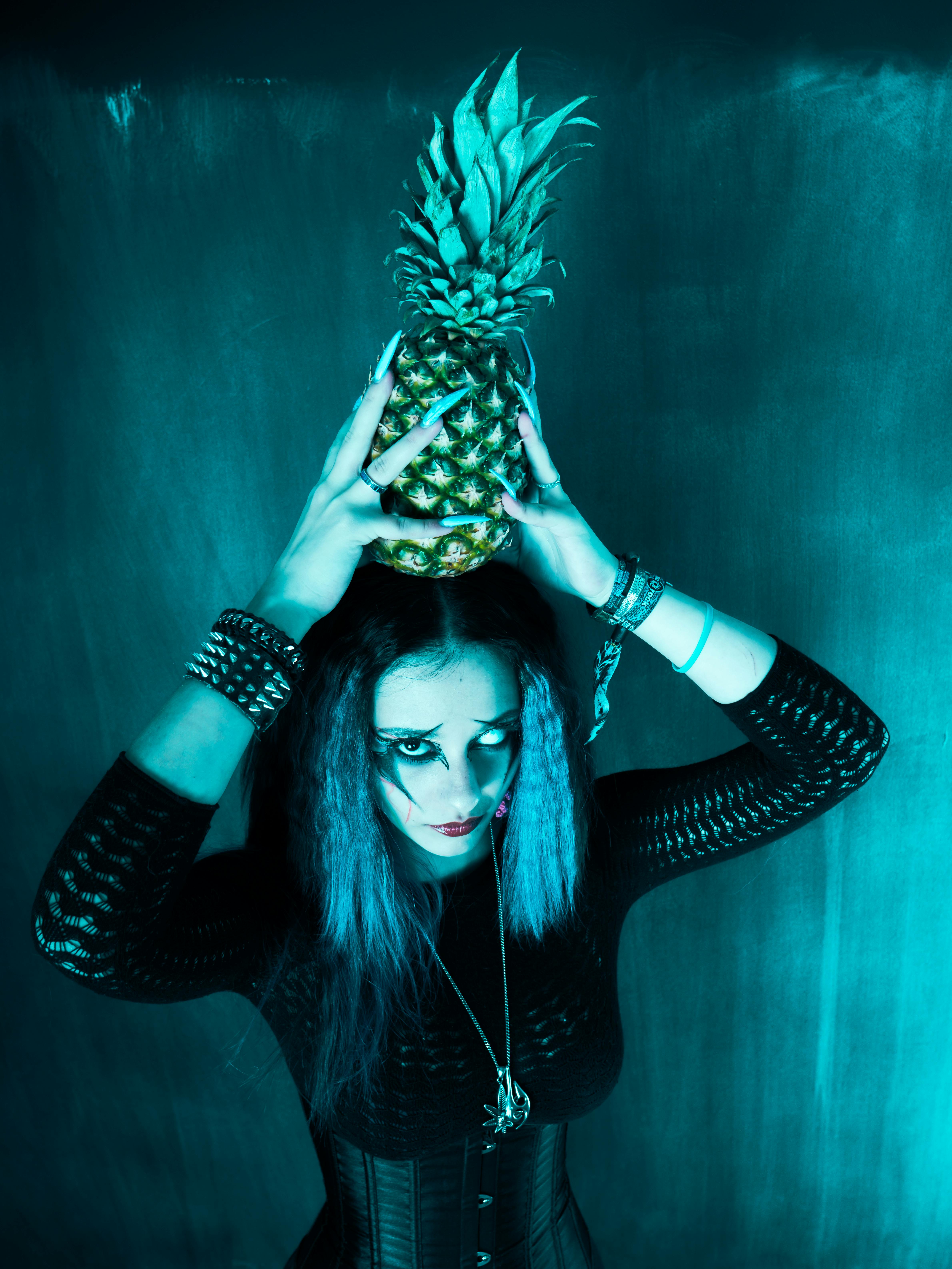 Woman in Halloween Makeup Holding Pineapple in Raised Arms · Free Stock ...