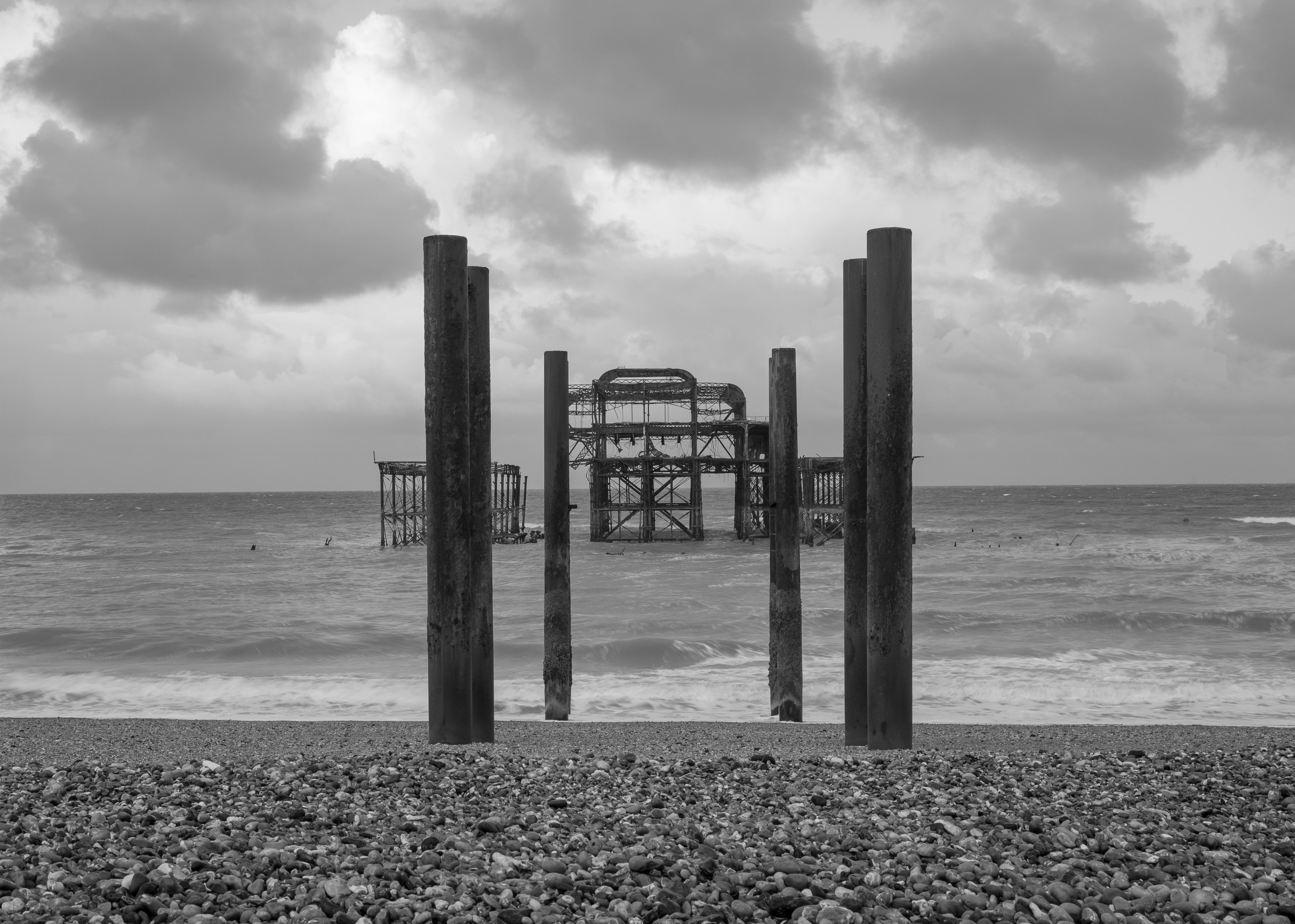 Wooden Posts and Construction on Sea Shore behind · Free Stock Photo