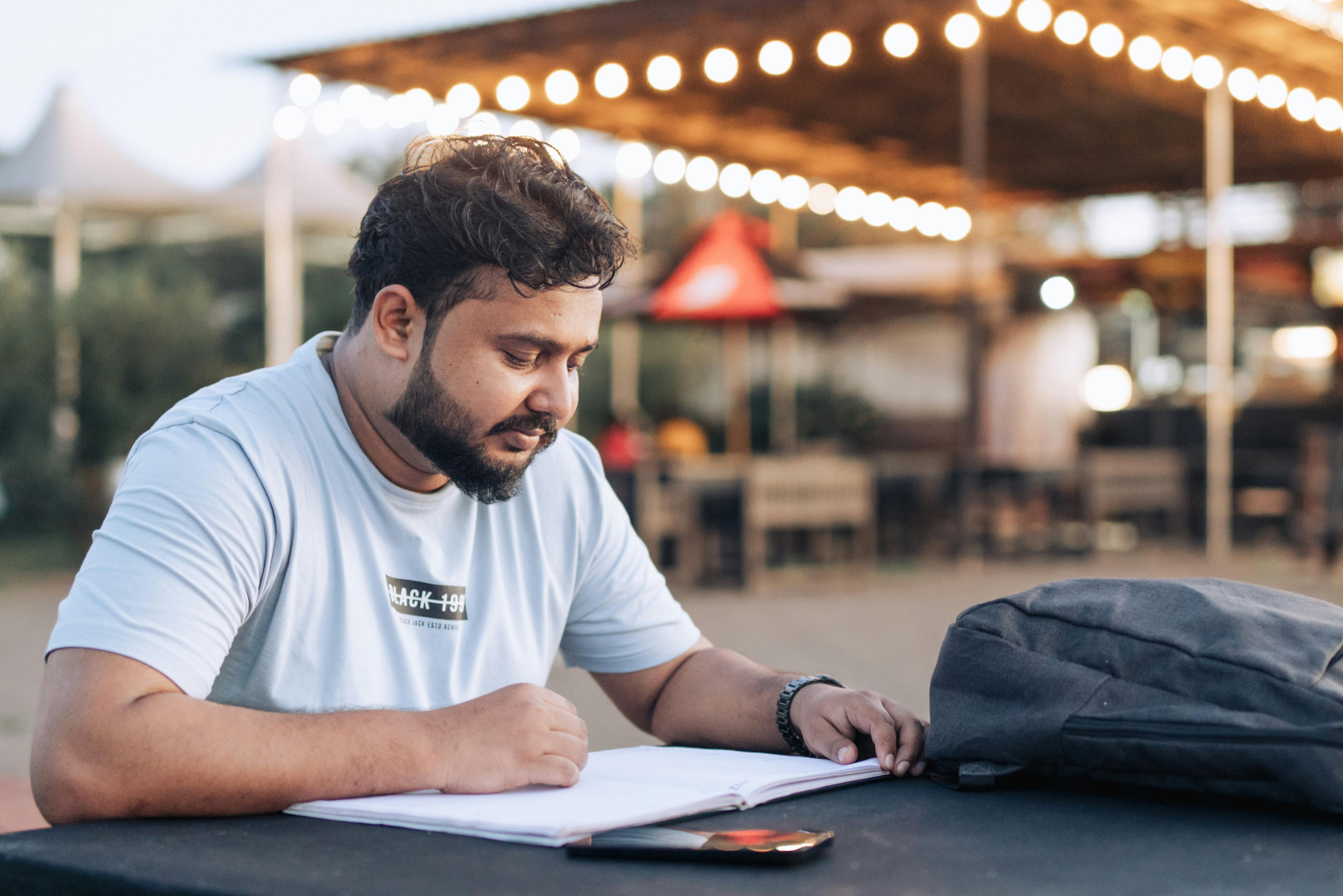 Student with Notebook Outdoors · Free Stock Photo