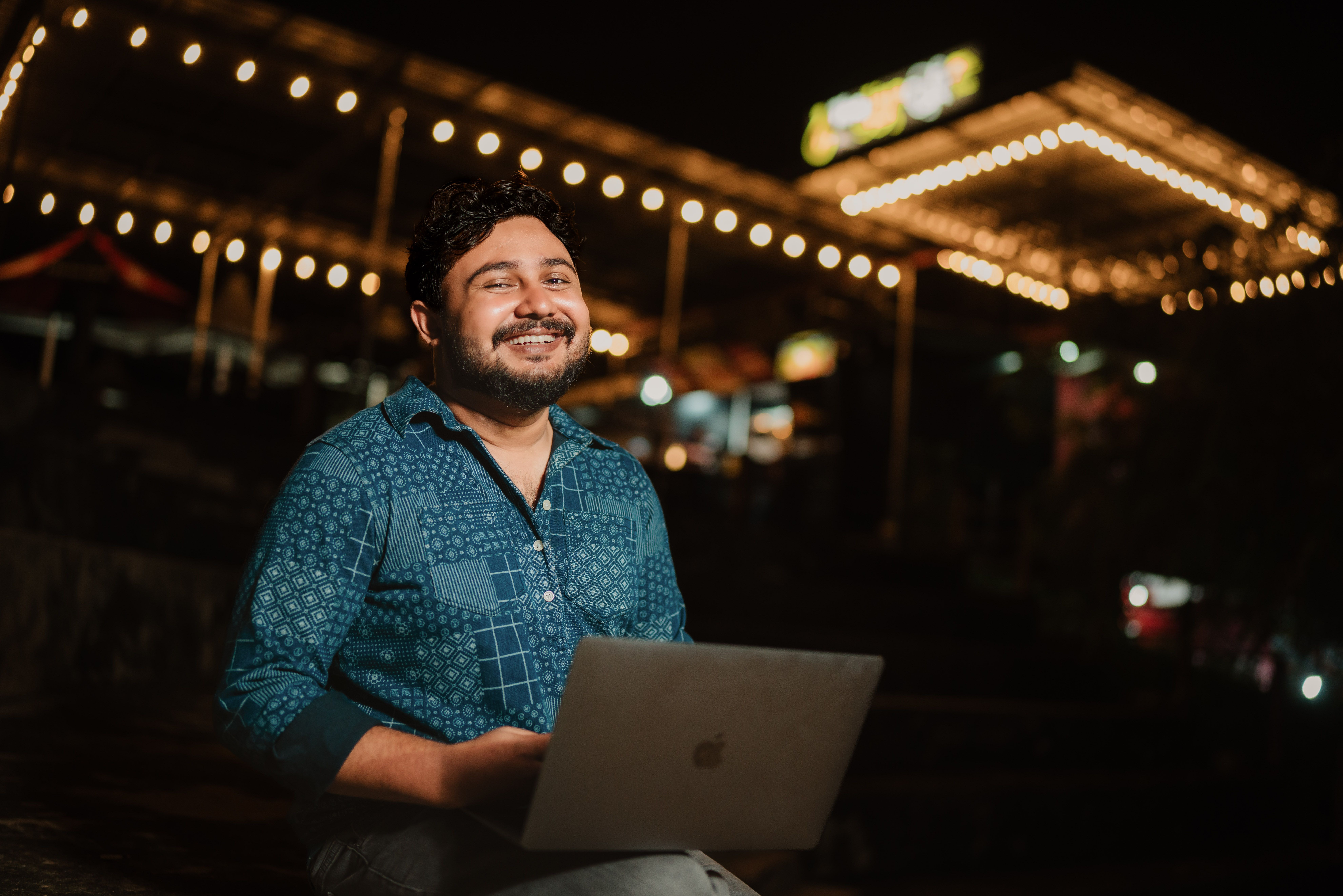 Smiling Geek Man With Computer on Laps · Free Stock Photo